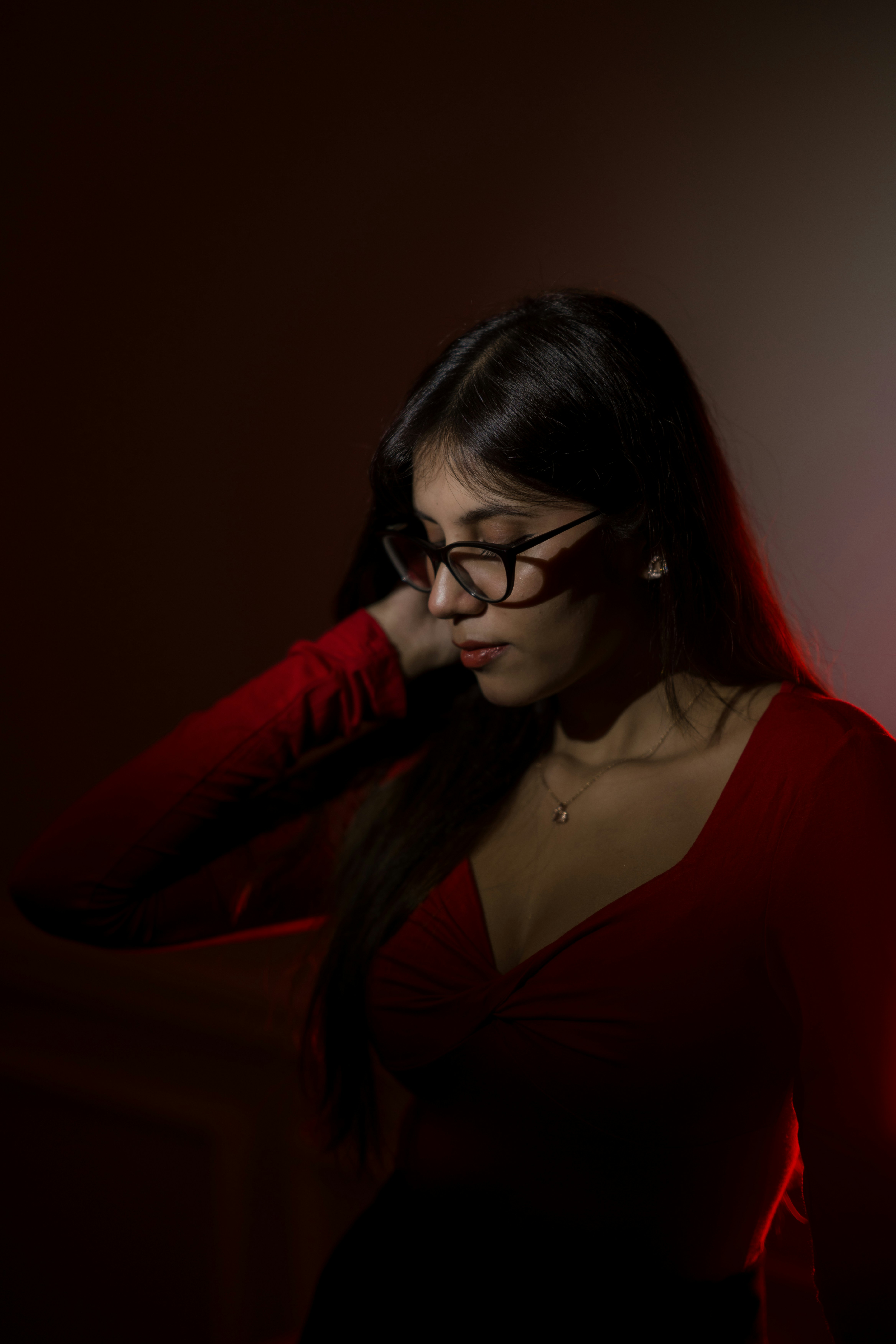 A woman in red poses in dramatic lighting. photo – Free Portrait Image ...