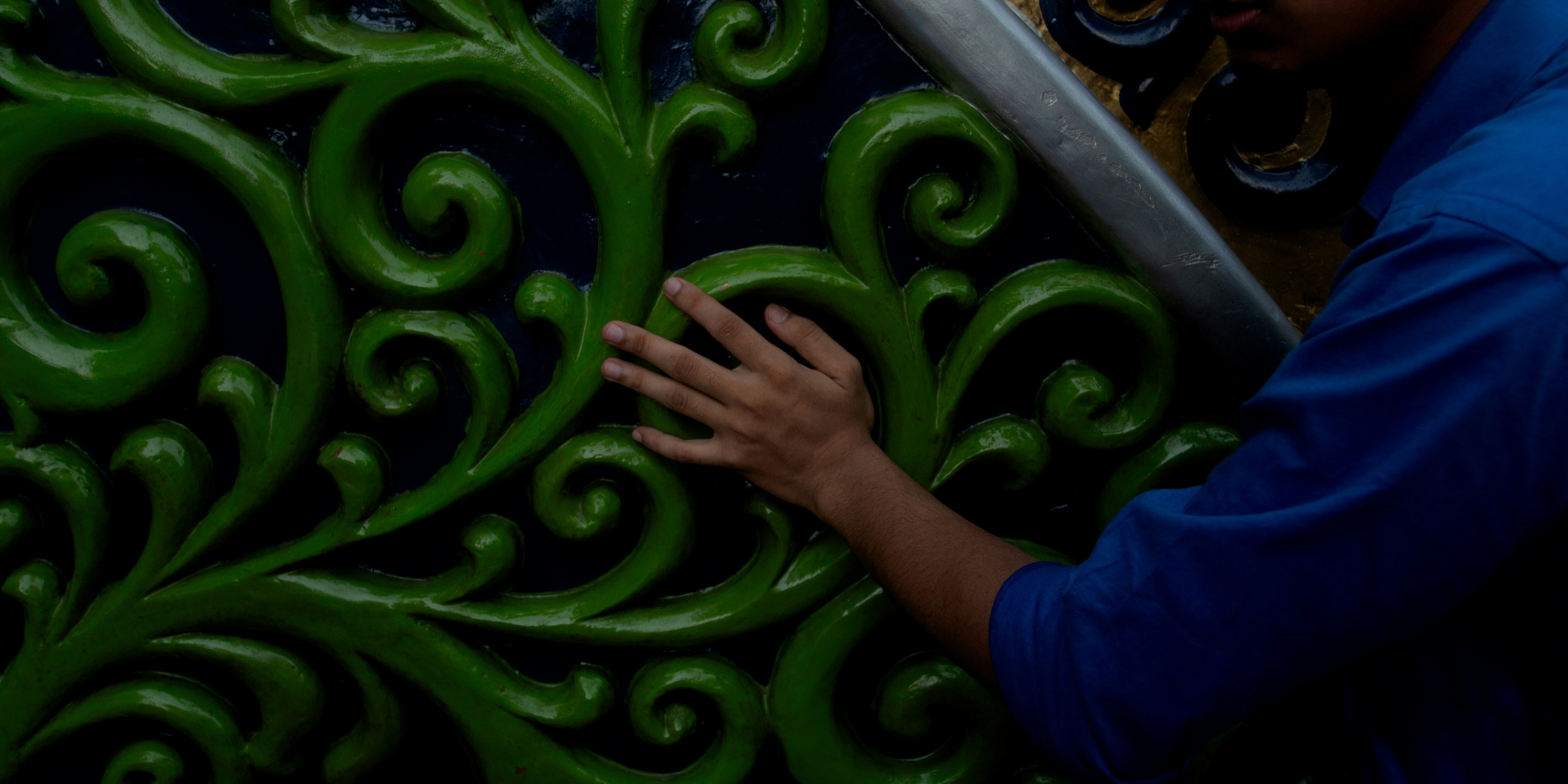 Grasp on Verdant Iron: A Hand Resting Among Swirling Gatework