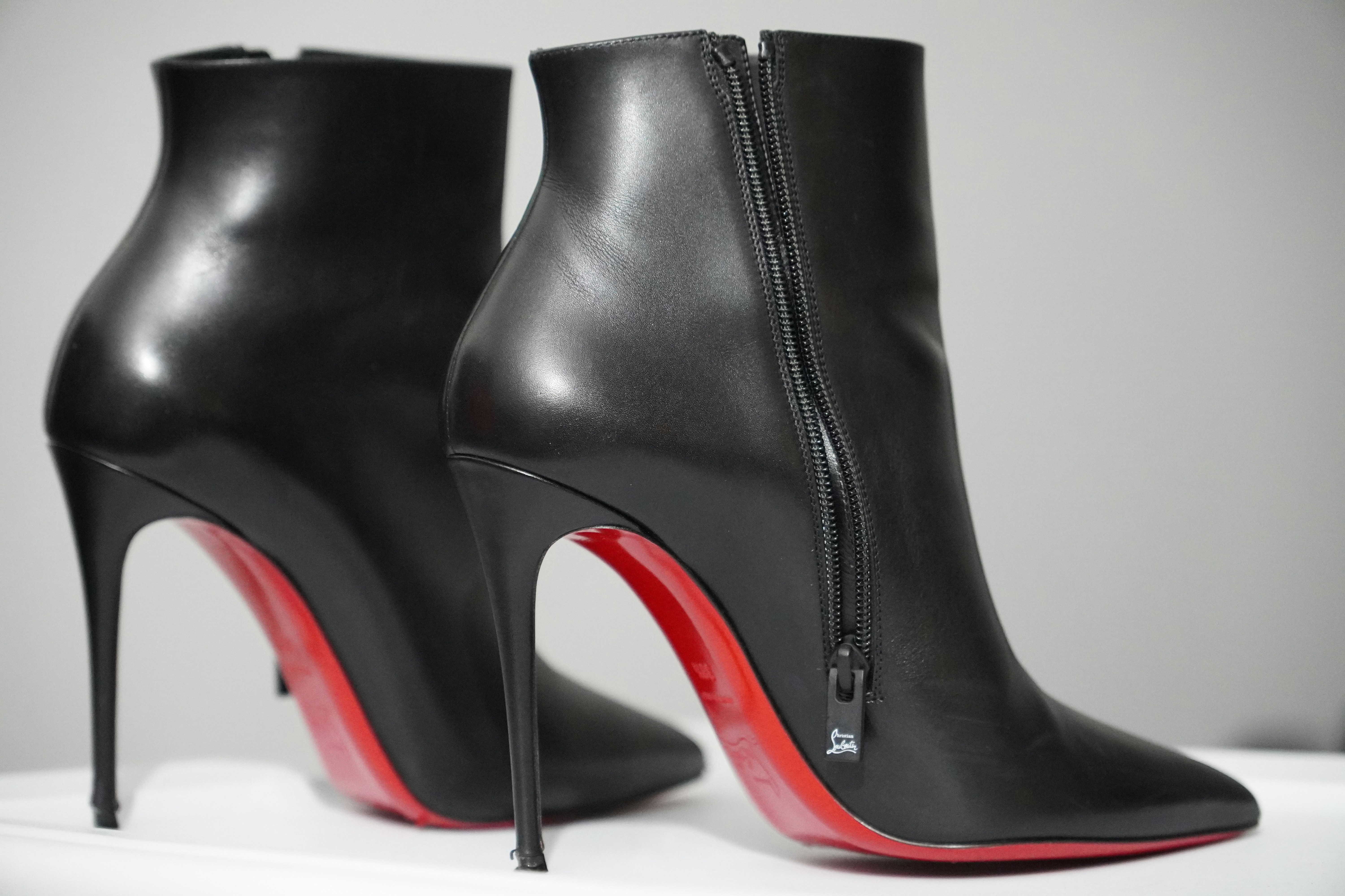 Black high-heeled boots with red soles are shown. photo – Free Shoe ...