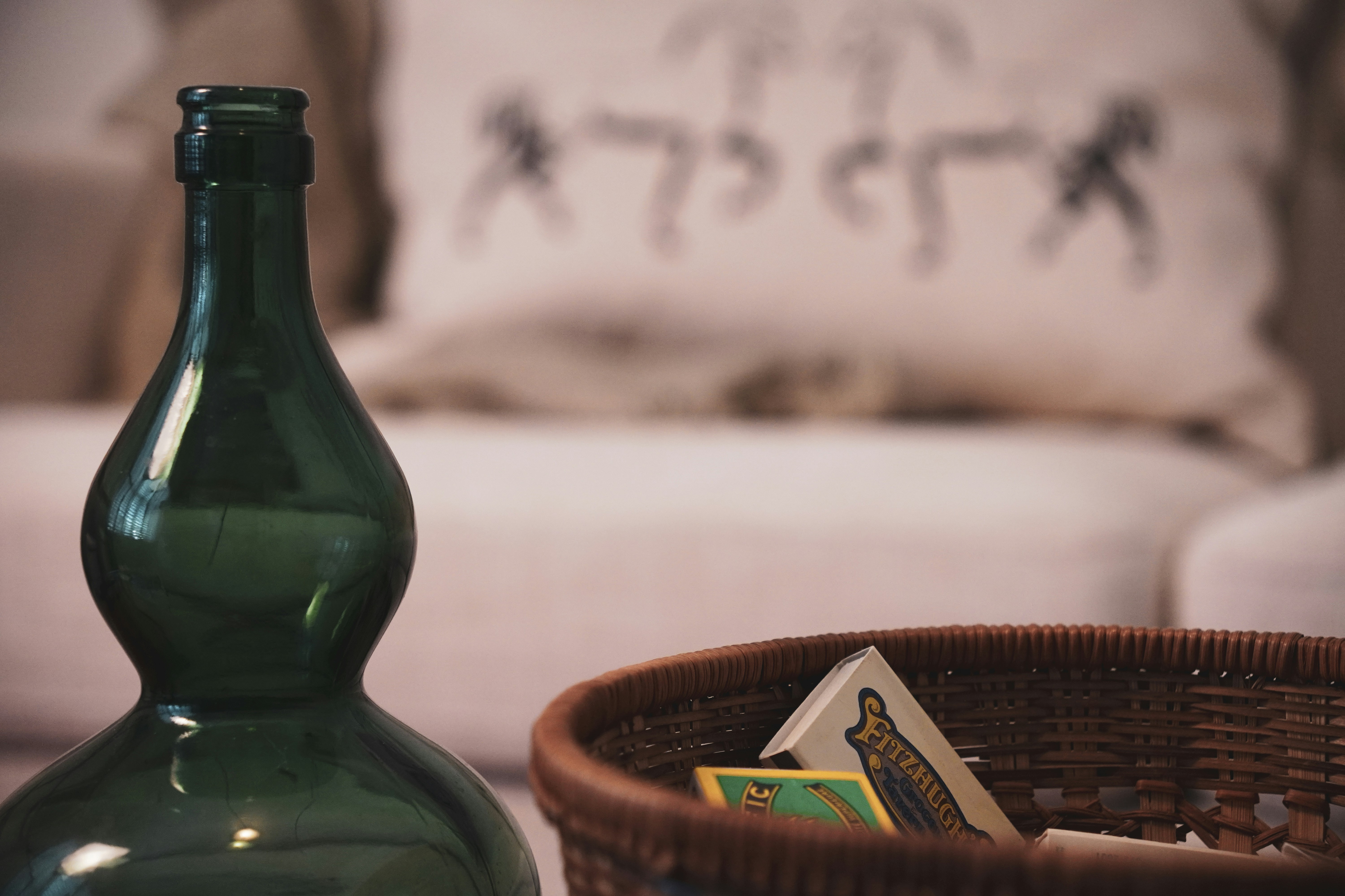 Green Bottle in a Cozy Corner: A Quiet Still Life with Wicker and Warm Light