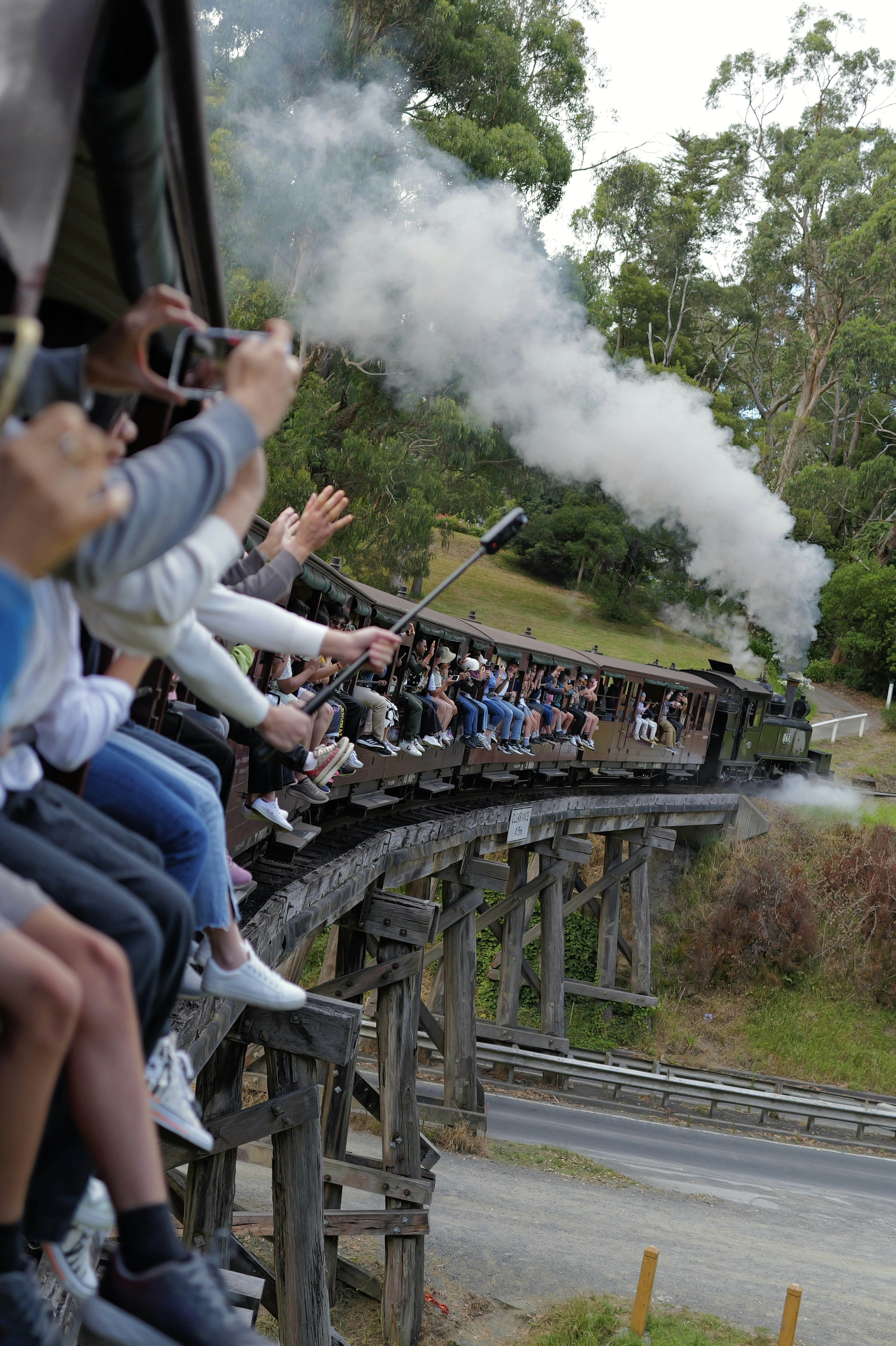 Steam and spectators: a wooden incline carries a crowd toward the horizon as the train belches smoke