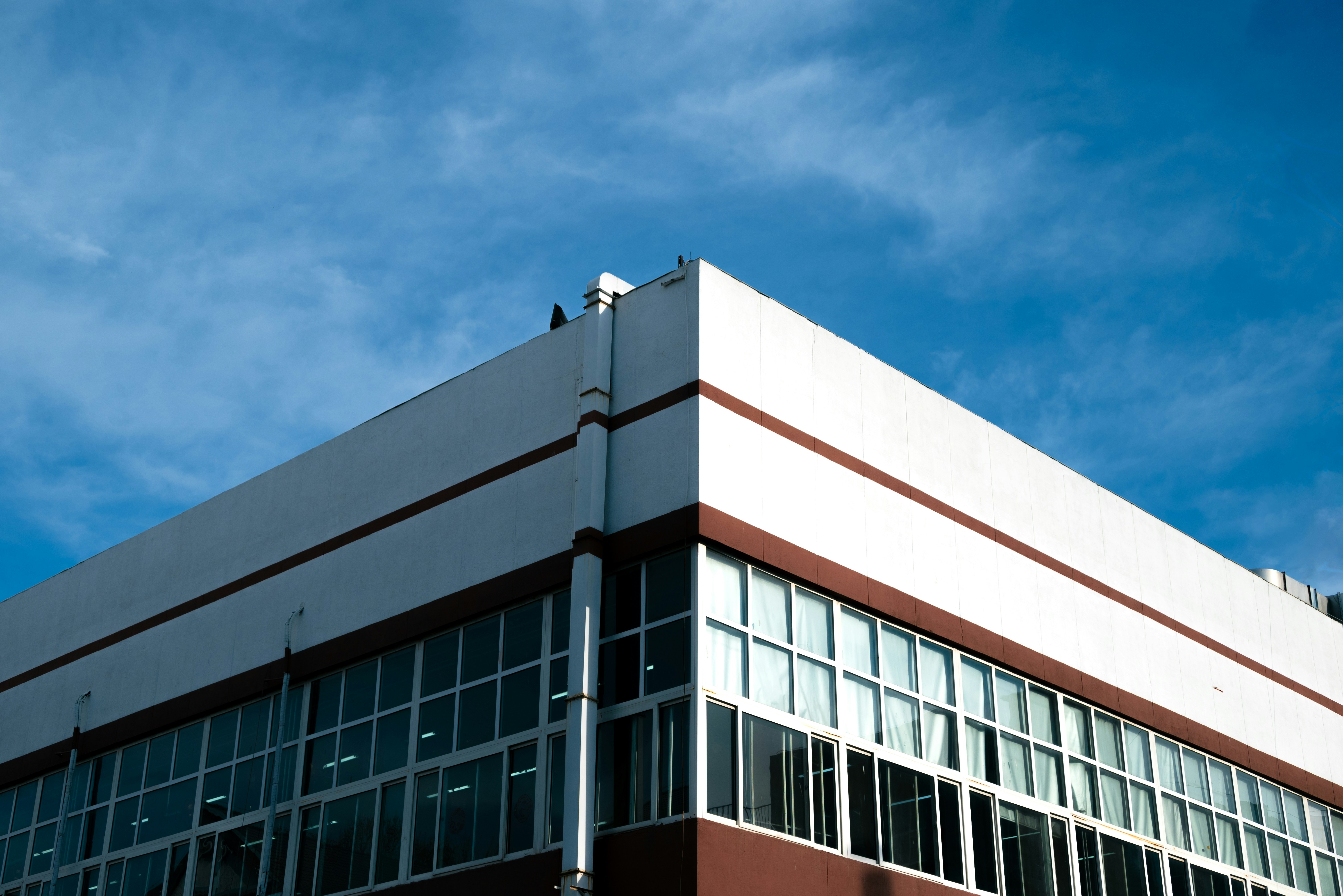 Modern building with large windows against a blue sky. photo – Free ...