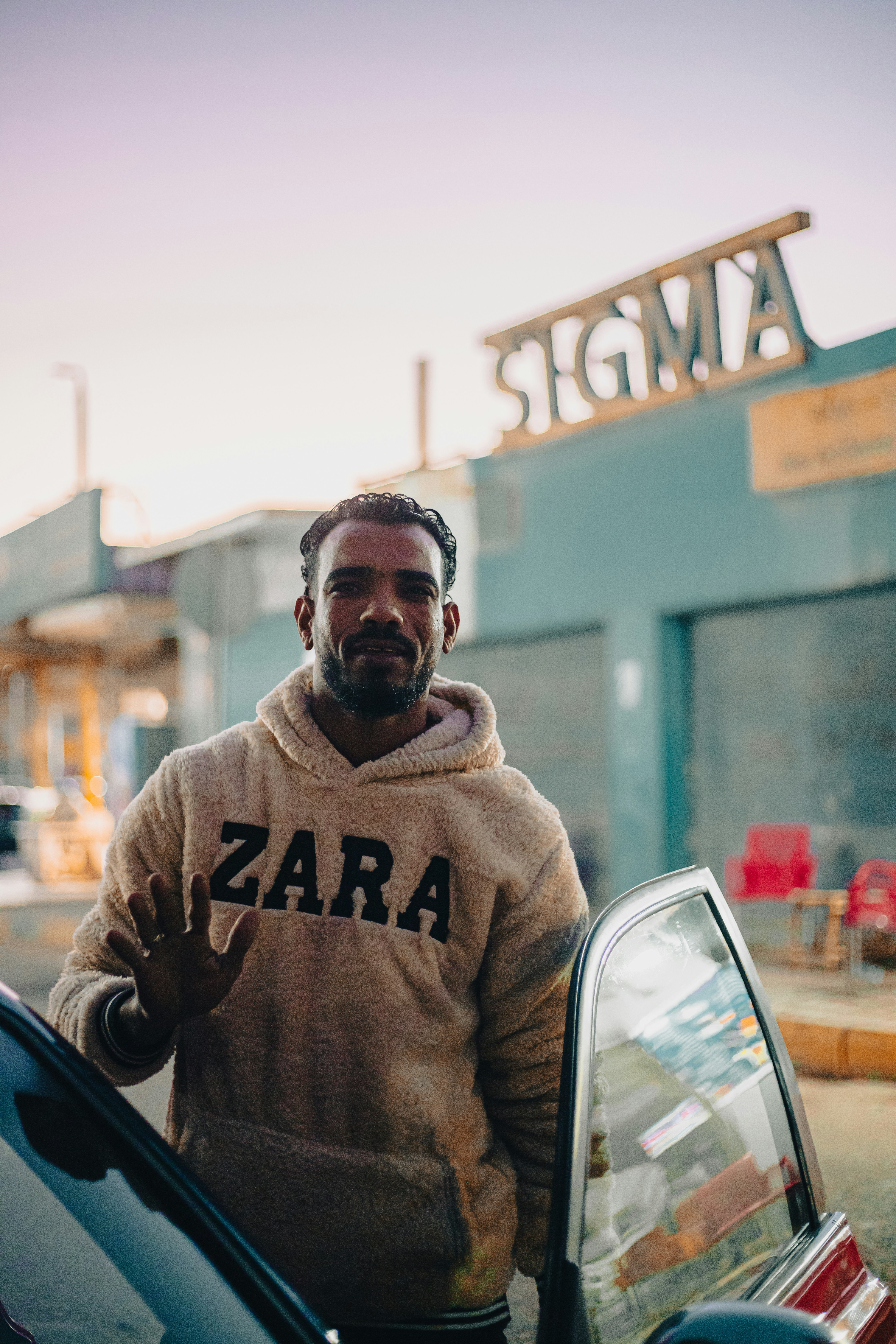 Dusk Portrait at the Turquoise Storefront: A ZARA Hoodie Moment