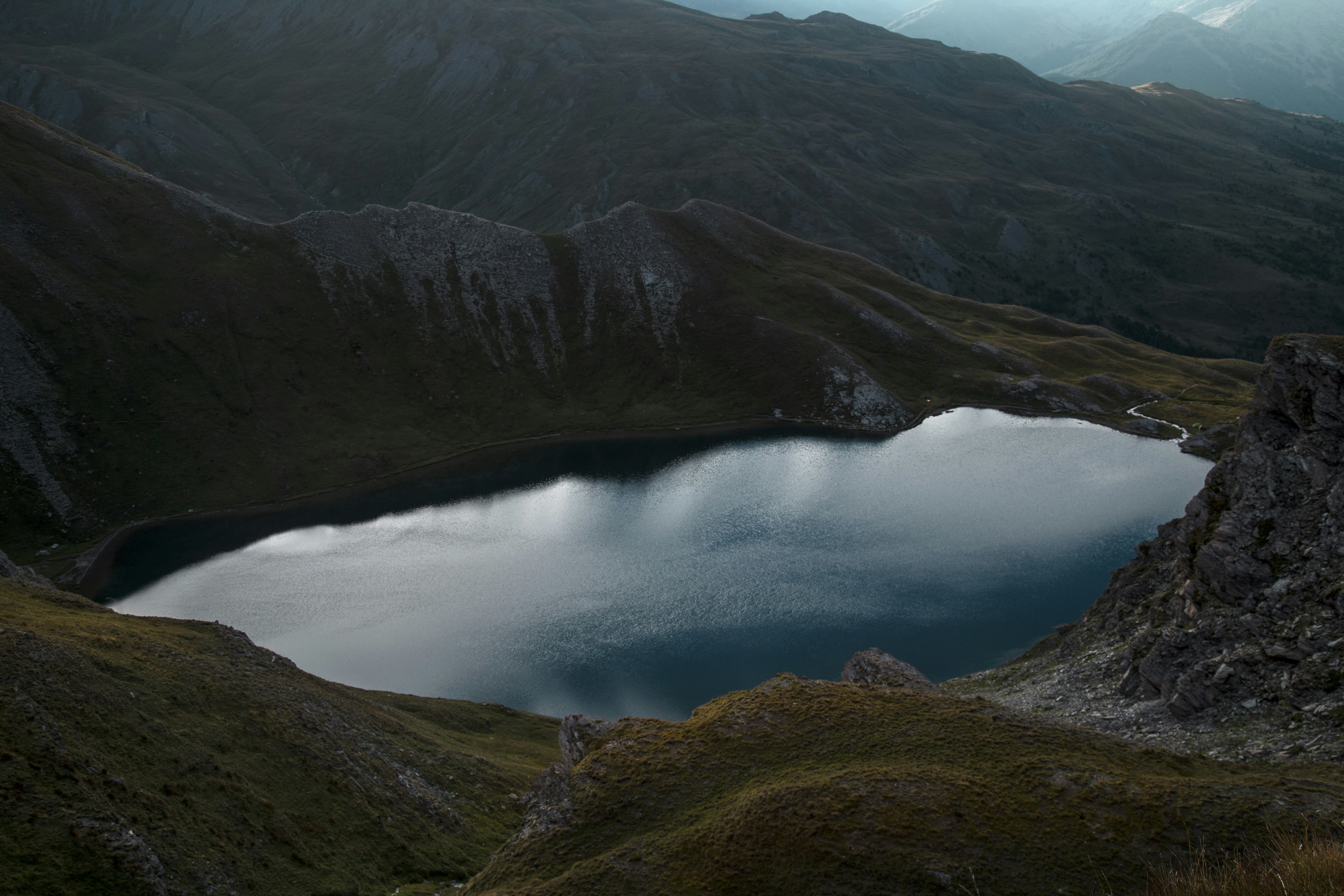 Mountain lake reflecting the early morning sky in the French Alps.