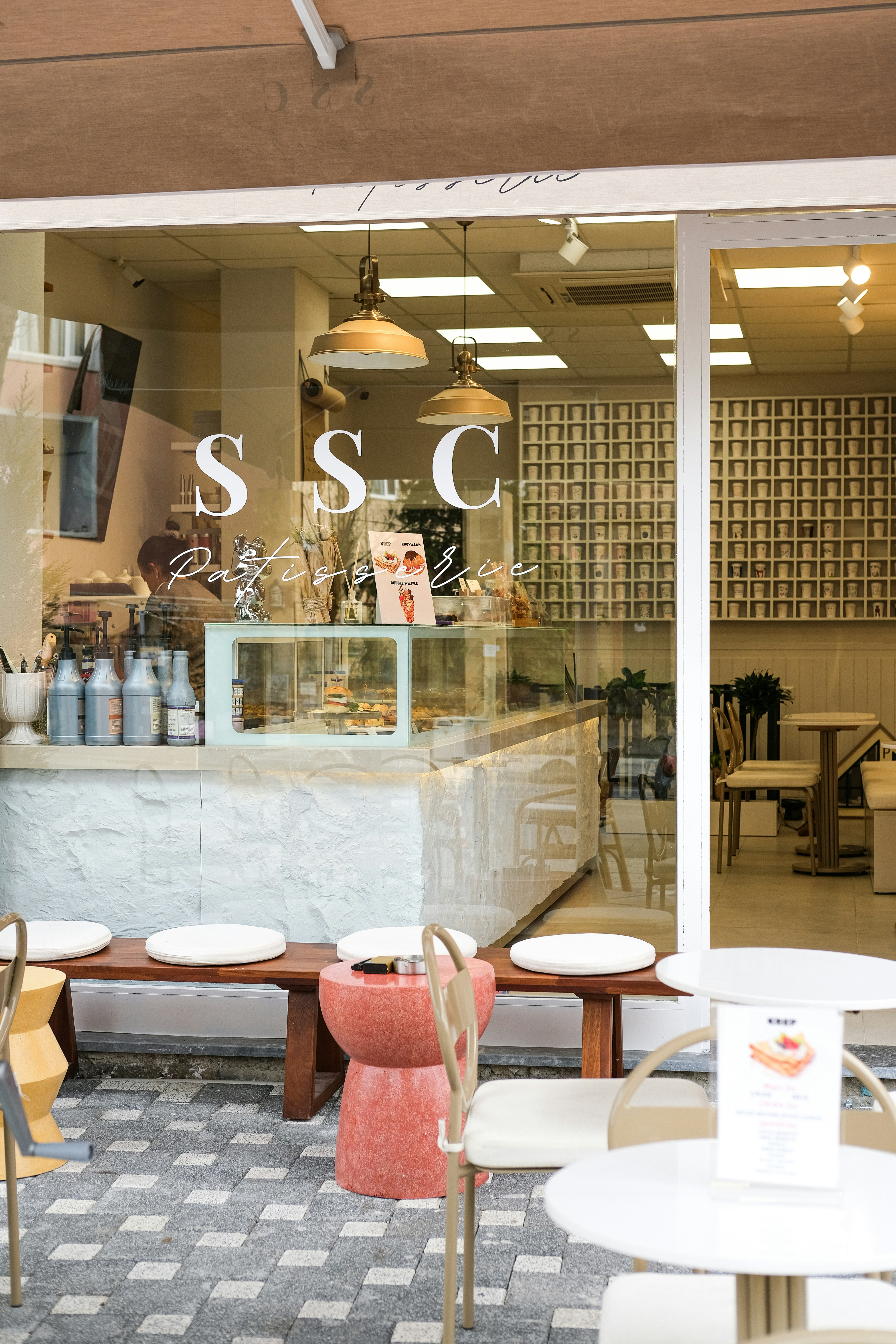 Glass-front Café: Soft Light, Quiet Tables, and Street-dining Echoes