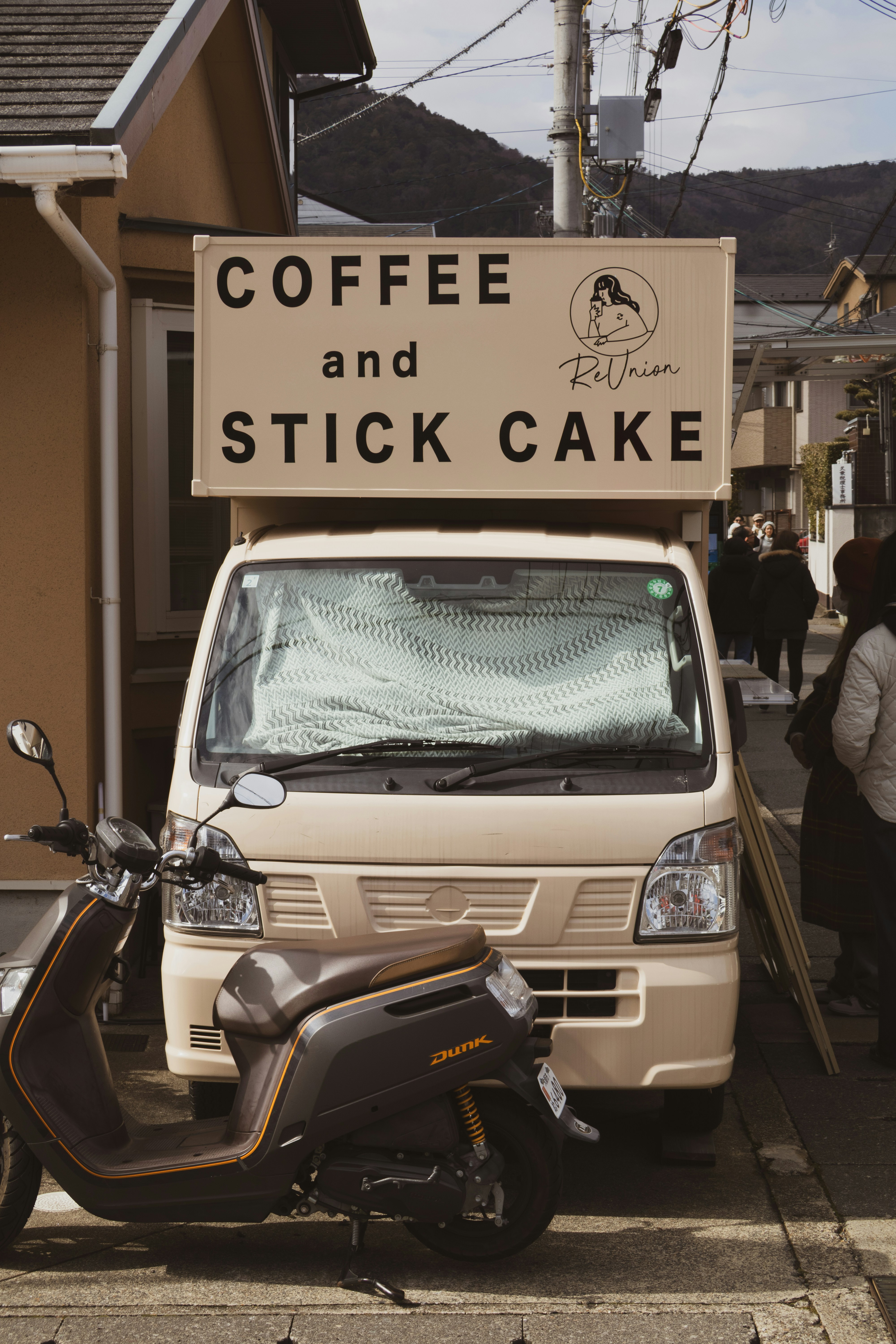 On the way to the Arashiyama Bamboo Forest in Kyoto, Japan. | Coffee and stick cake are sold from a food truck.
