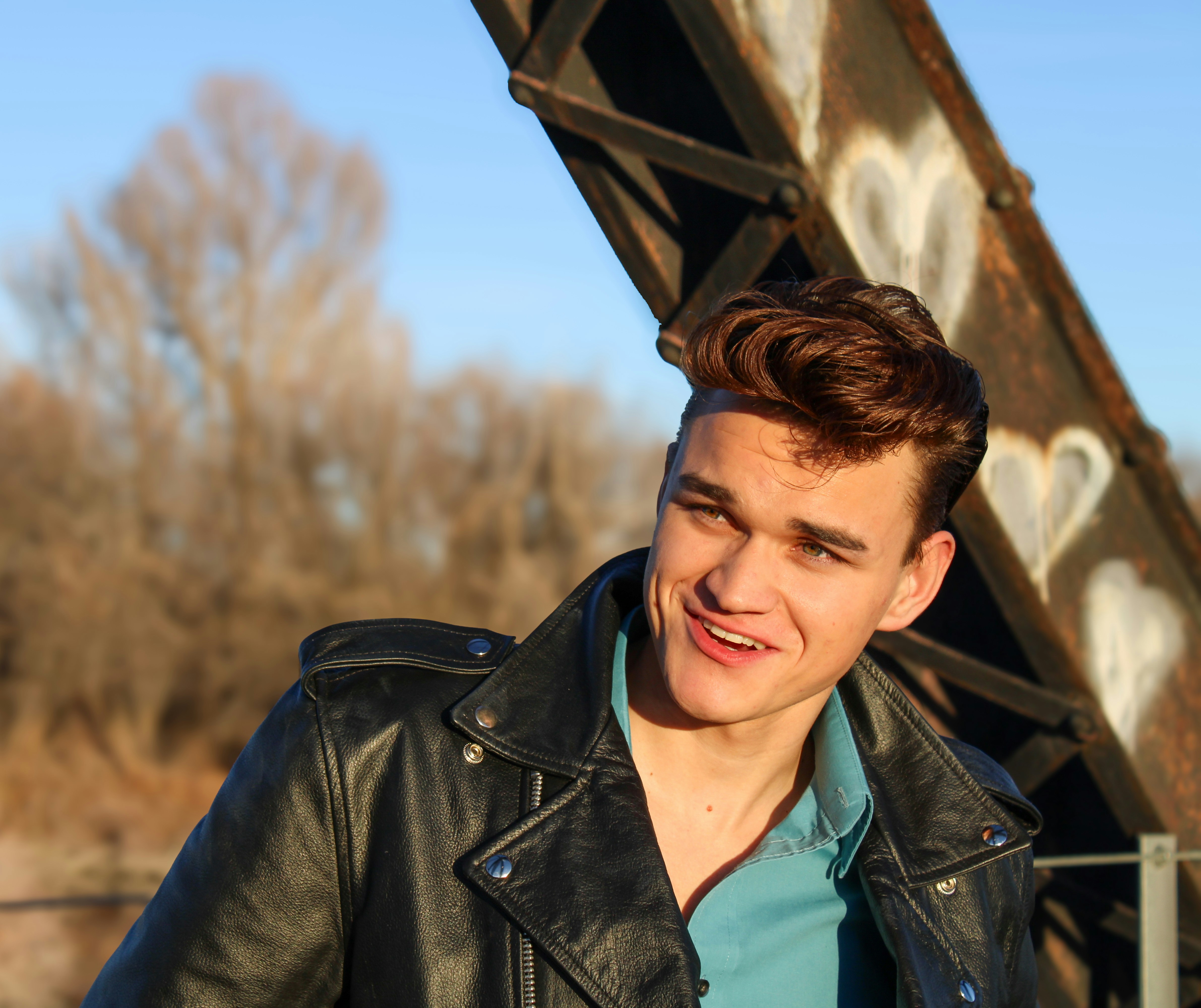 A man smiles, wearing a leather jacket. photo – Free Portrait Image on ...