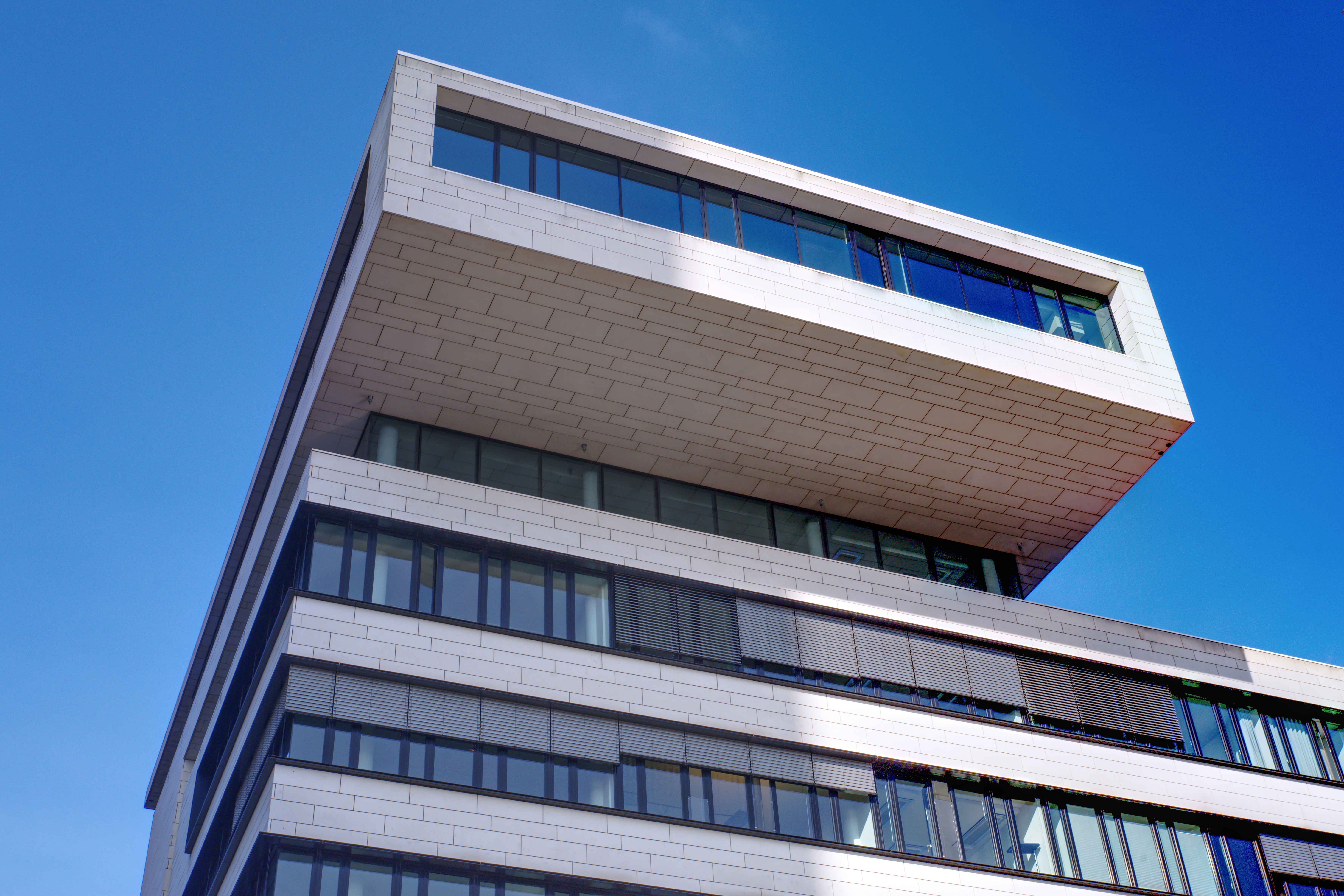 A modern building with a striking, protruding top. photo – Free ...