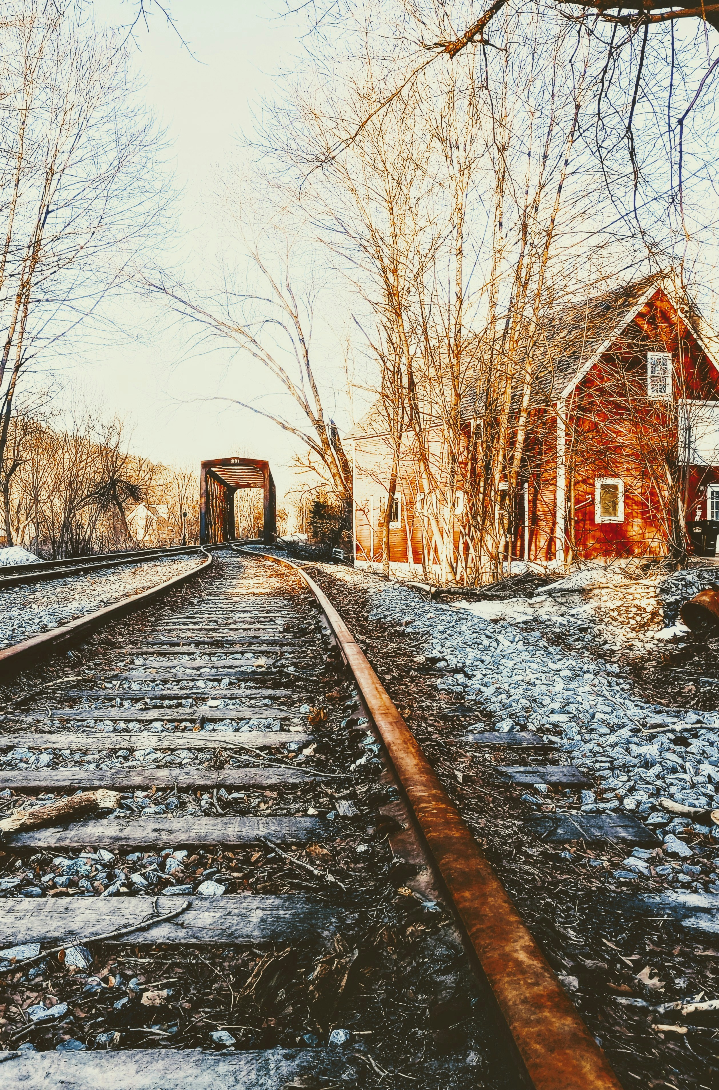Railroad tracks lead to a weathered building. photo – Free Usa Image on ...