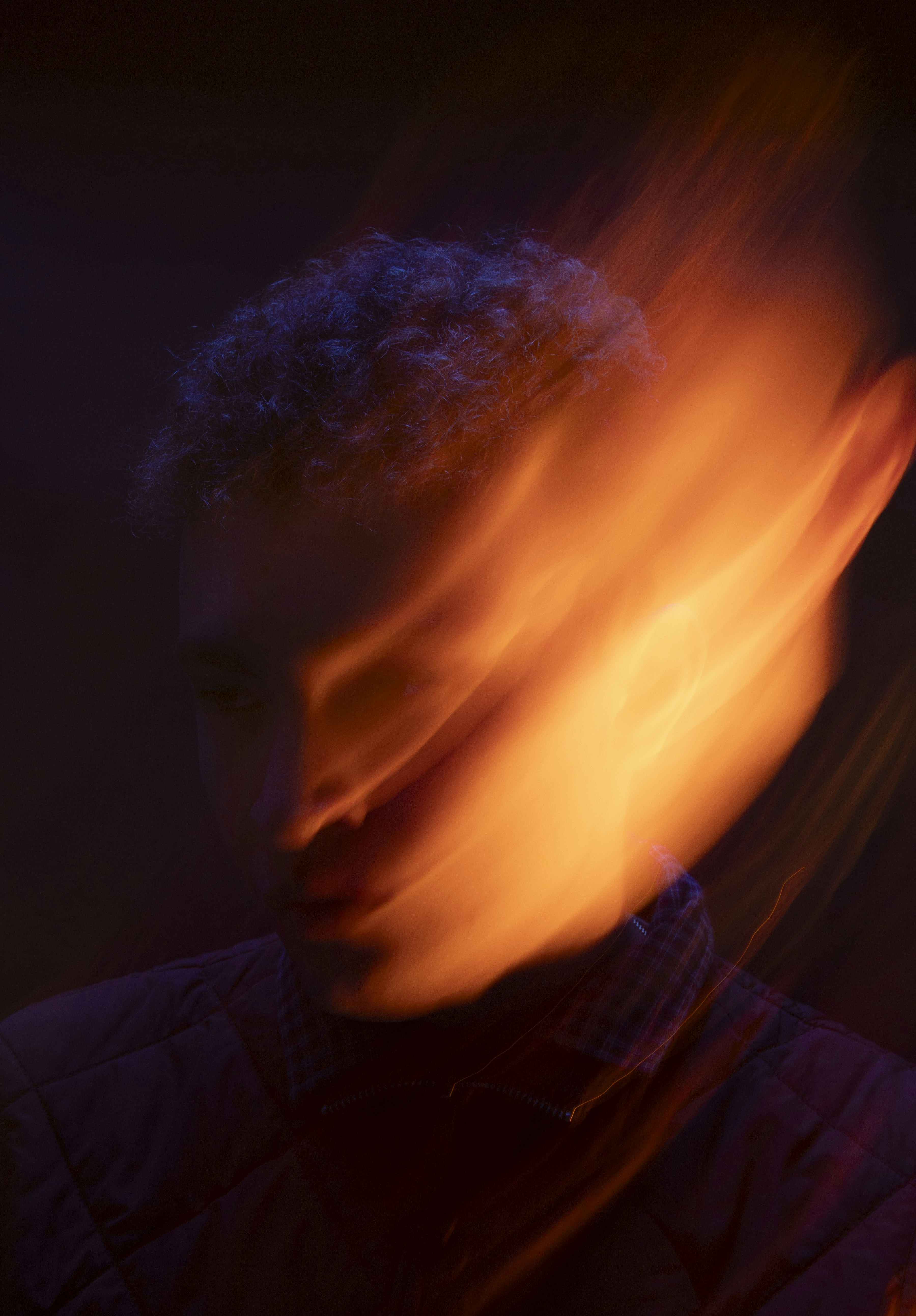Ember Portrait: A Quiet Face Intertwined with Moving Firelight