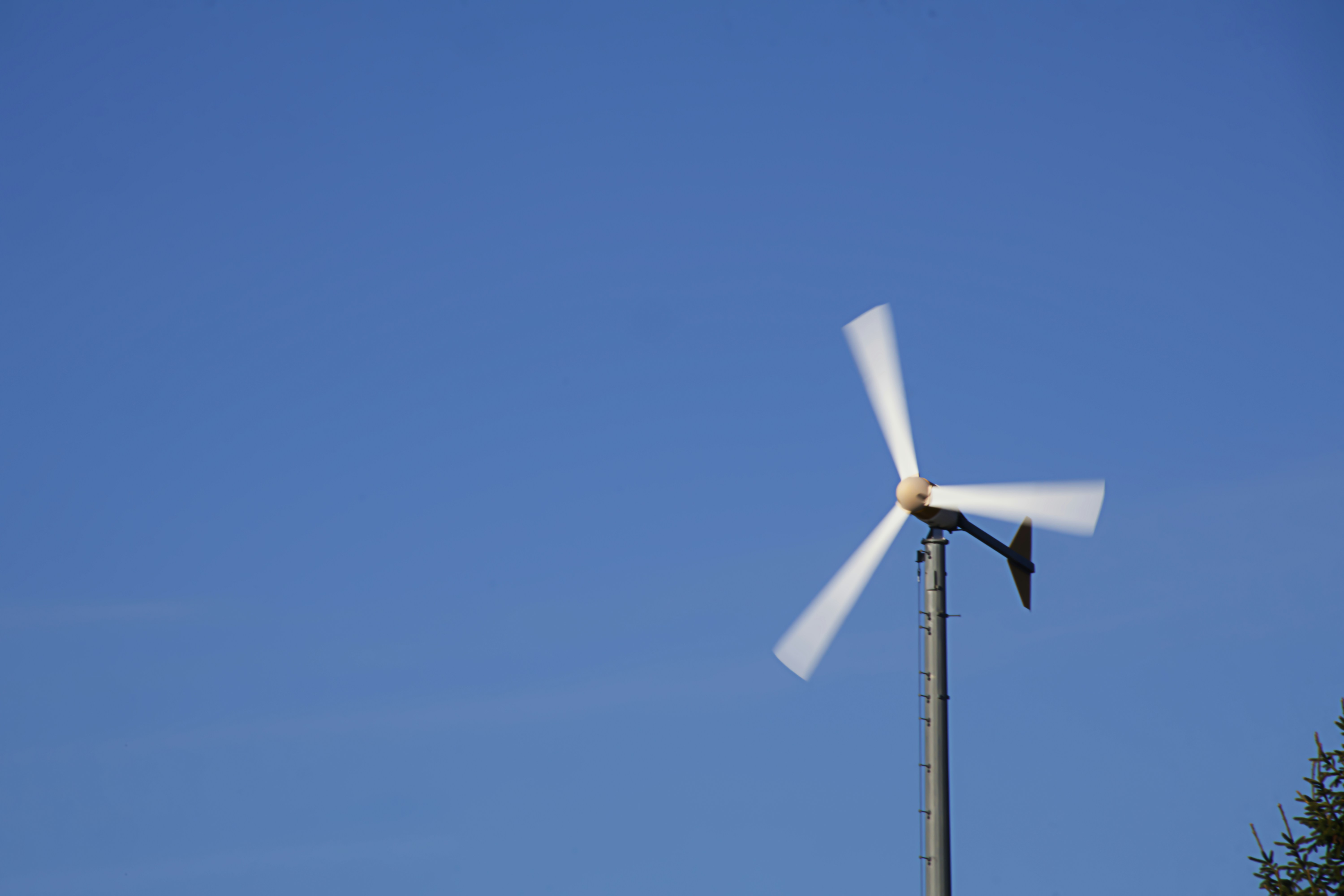 Turn of the Turbine: A Lone Wind Tower Against a Cobalt Sky