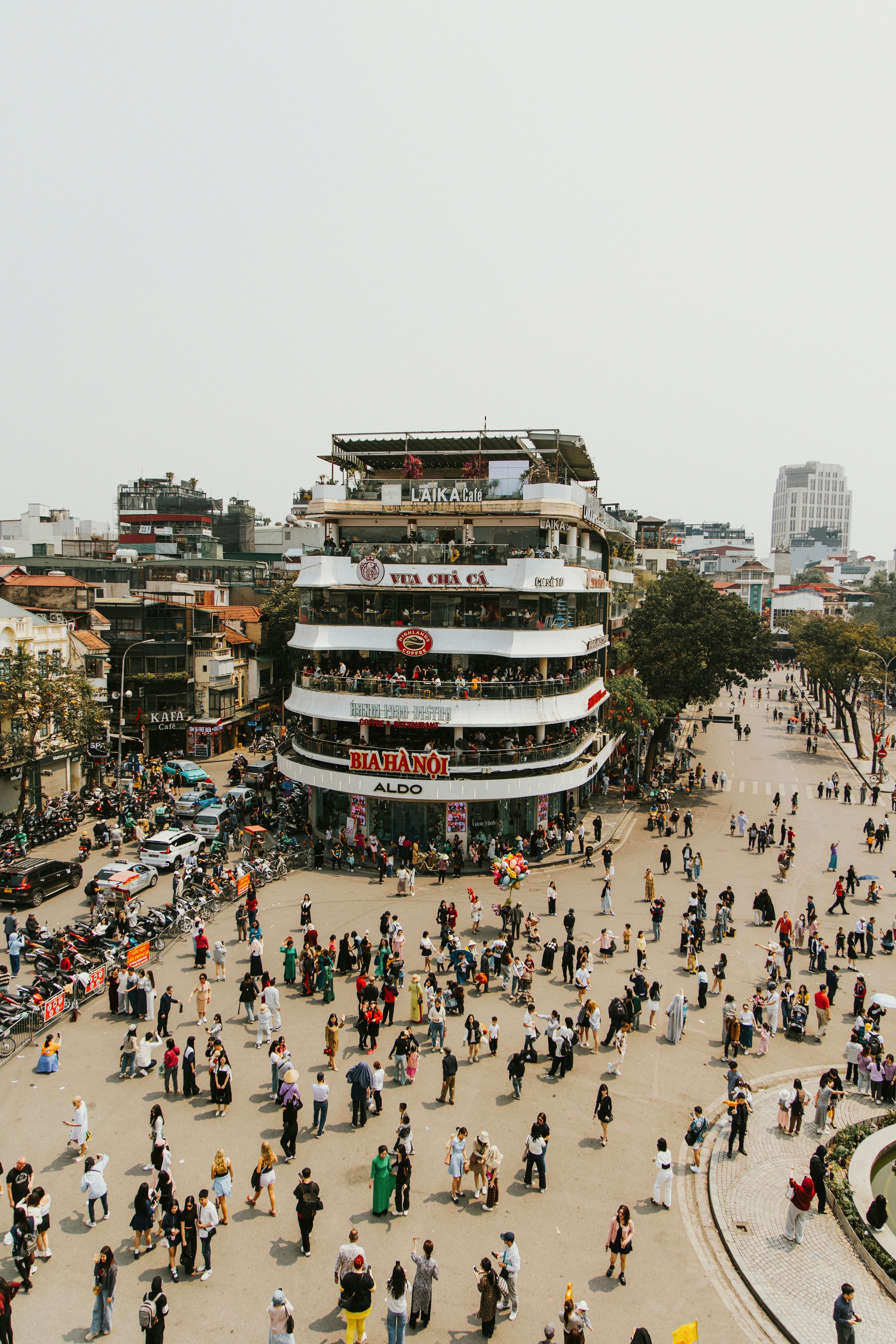 Hanoi's Circular Café Corner: A Crowded Living Mosaic