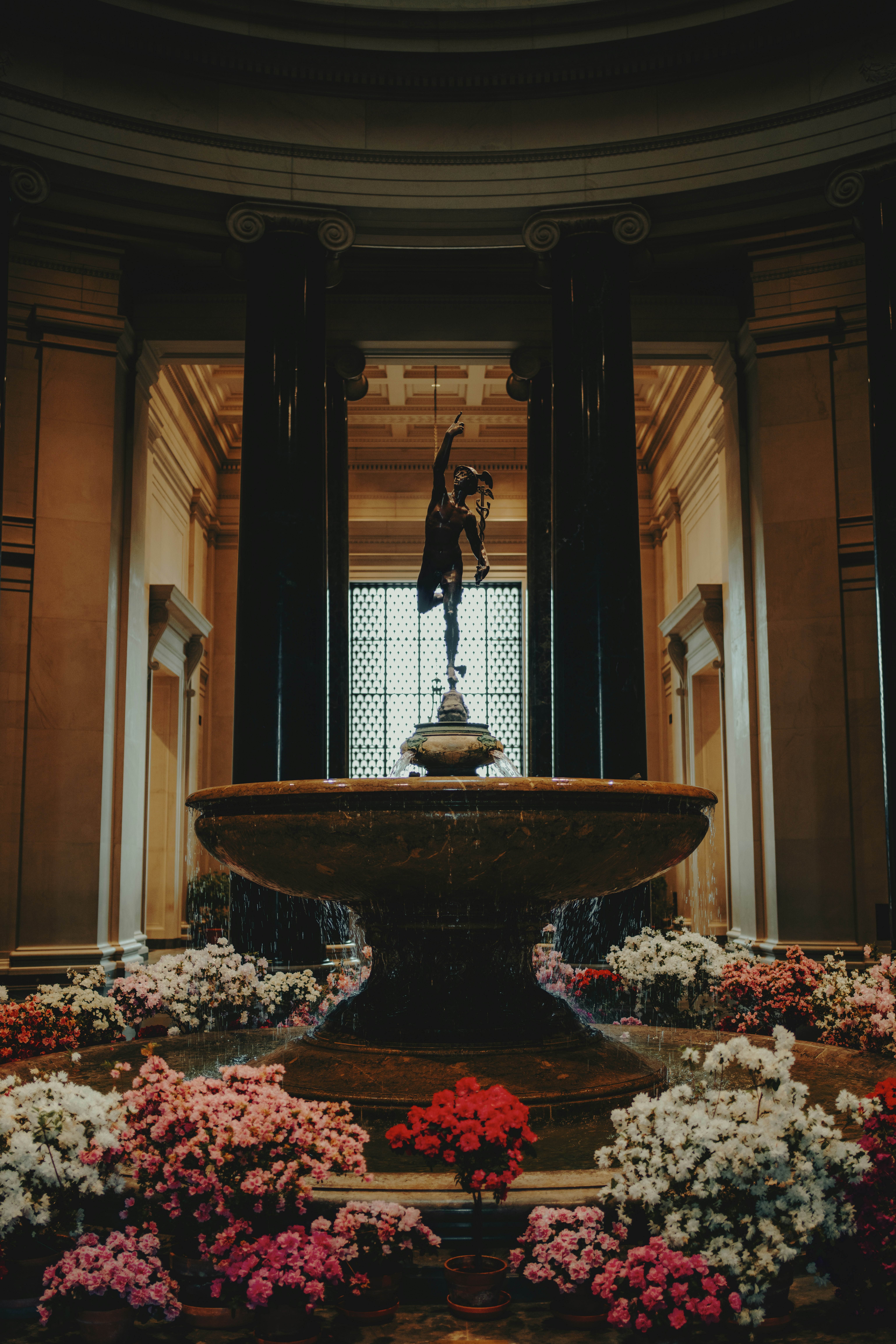 Statue Fountain in a Doric Hall Surrounded by Florals