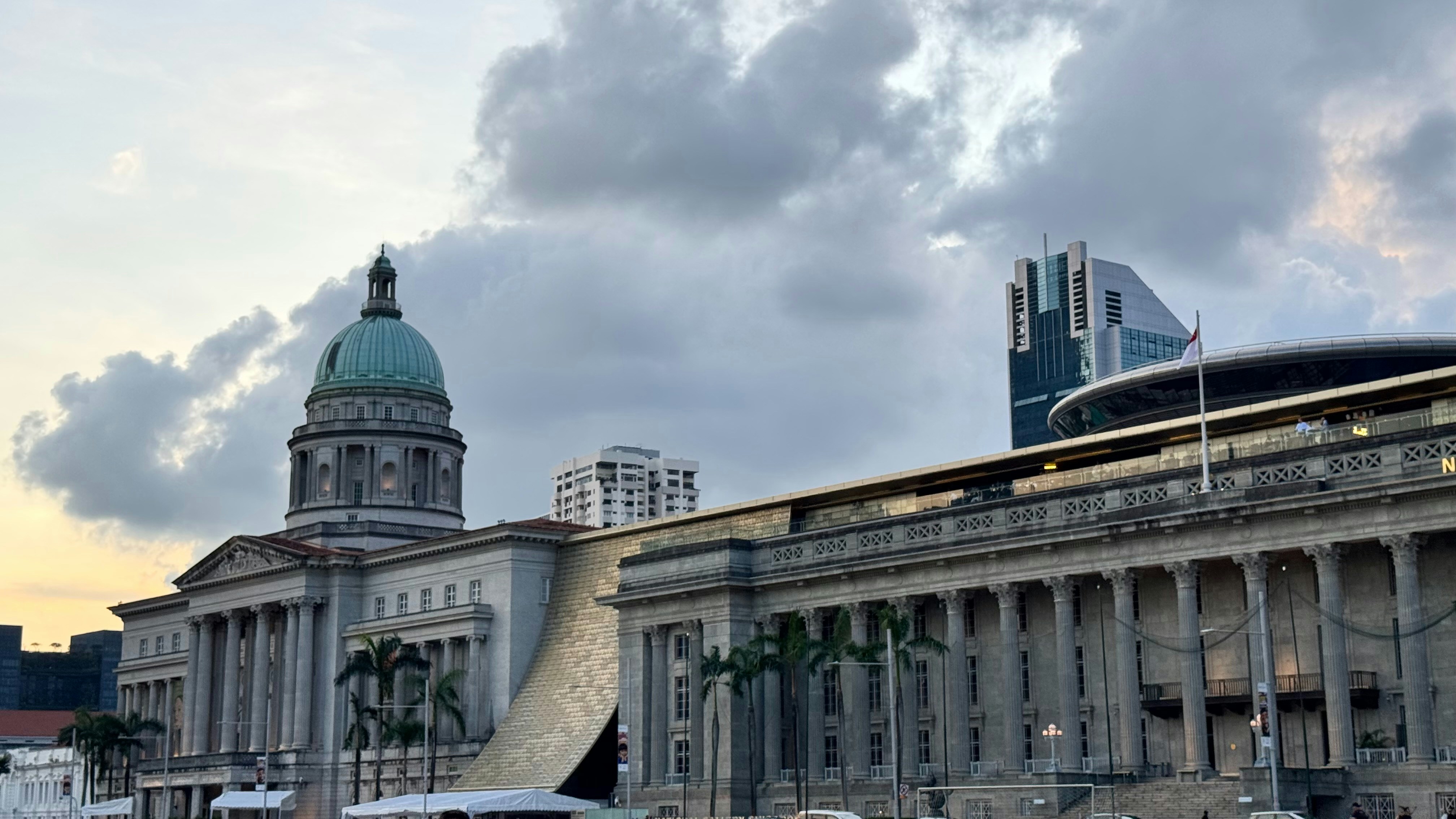 The National Gallery Singapore under a cloudy evening sky, with modern and classical elements in harmony.