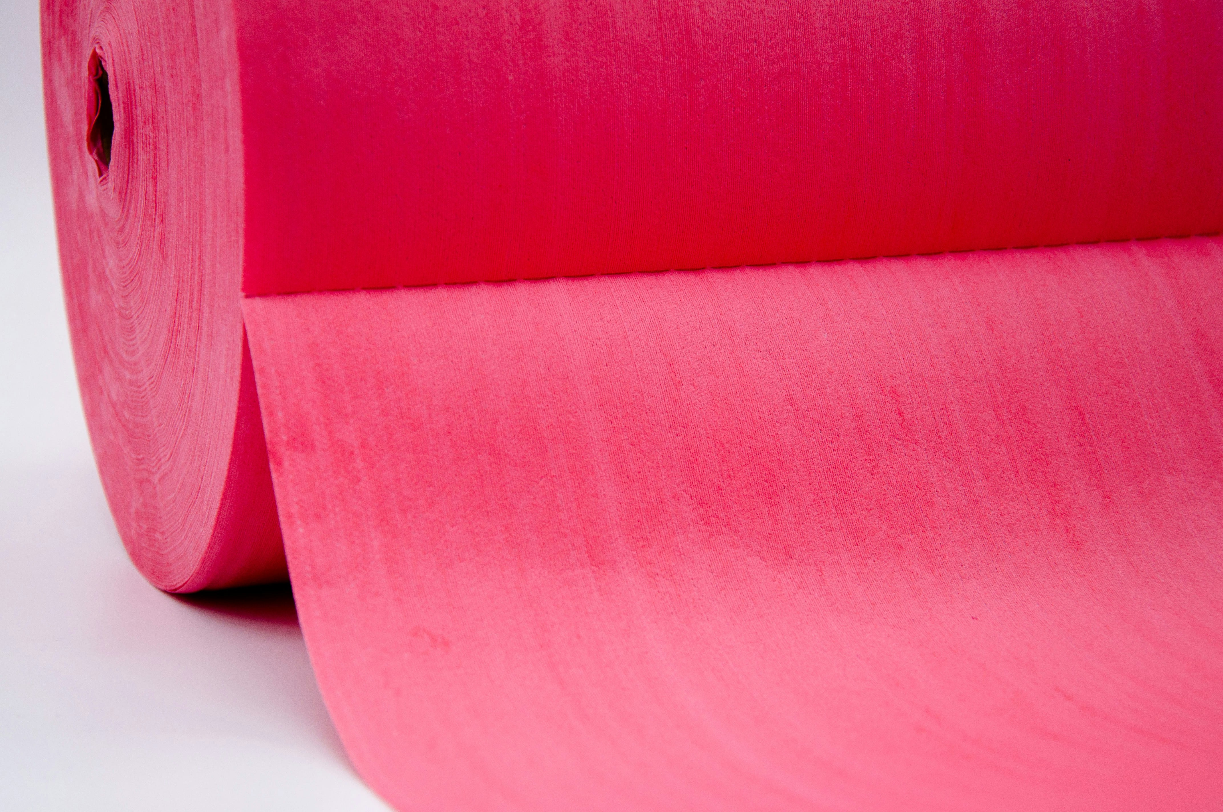 A roll of pink paper is being unfurled. photo – Free Paper Image on ...