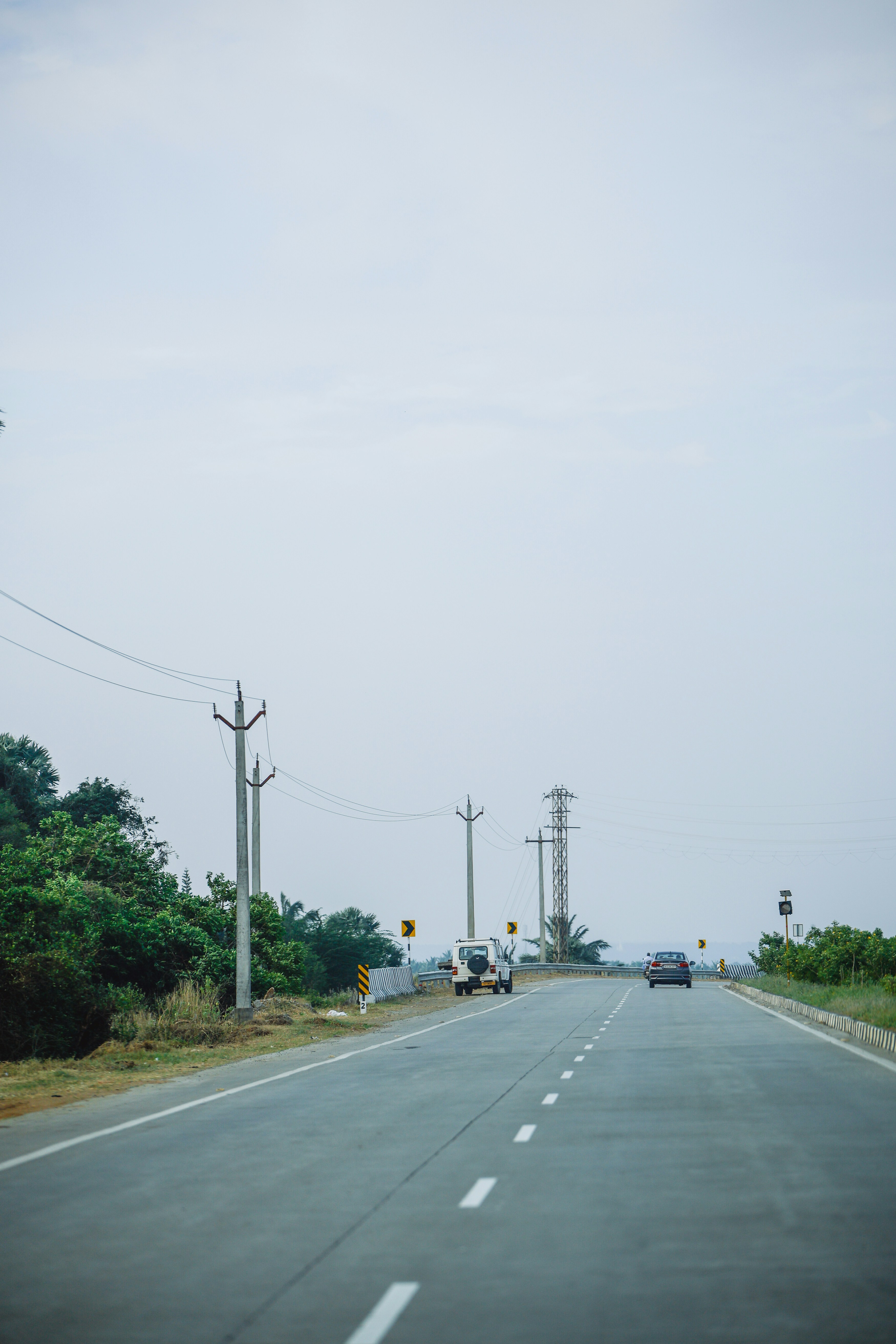A road stretches ahead with cars driving on it. photo – Free Wallpaper ...