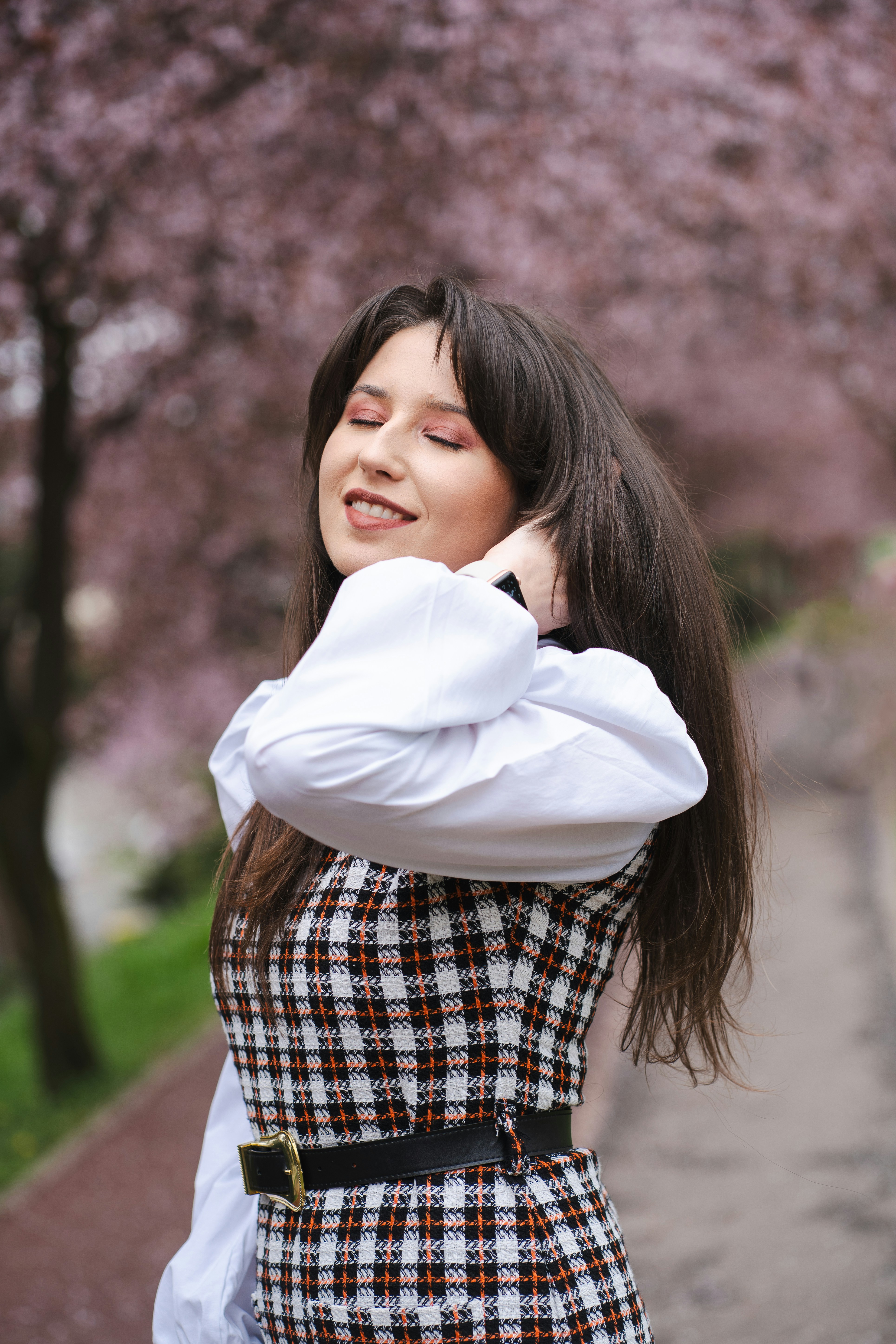 Woman smiles amidst blooming trees in spring. photo – Free Portrait ...