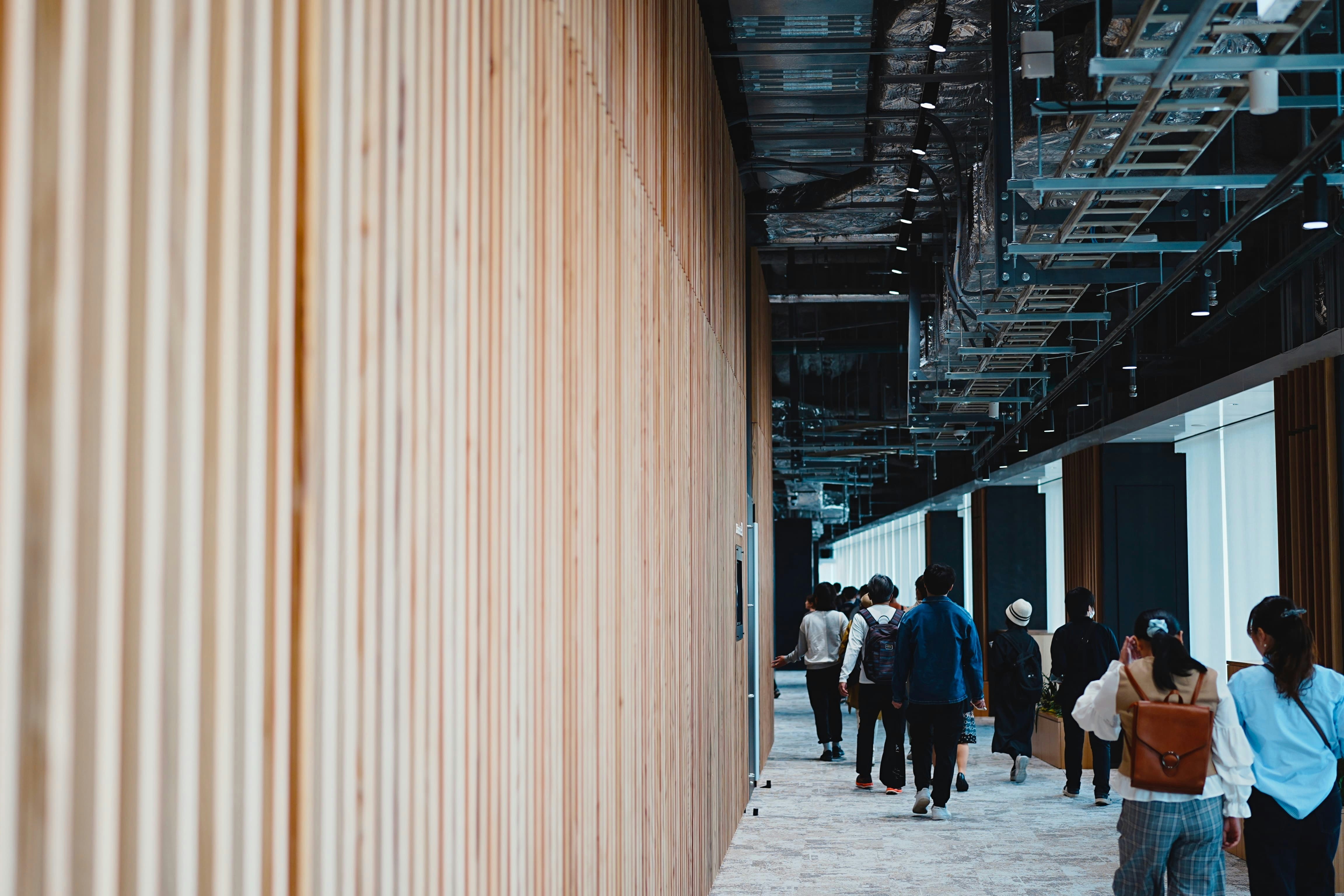 Corridor Convergence: A Quiet Crowd Under Industrial Light