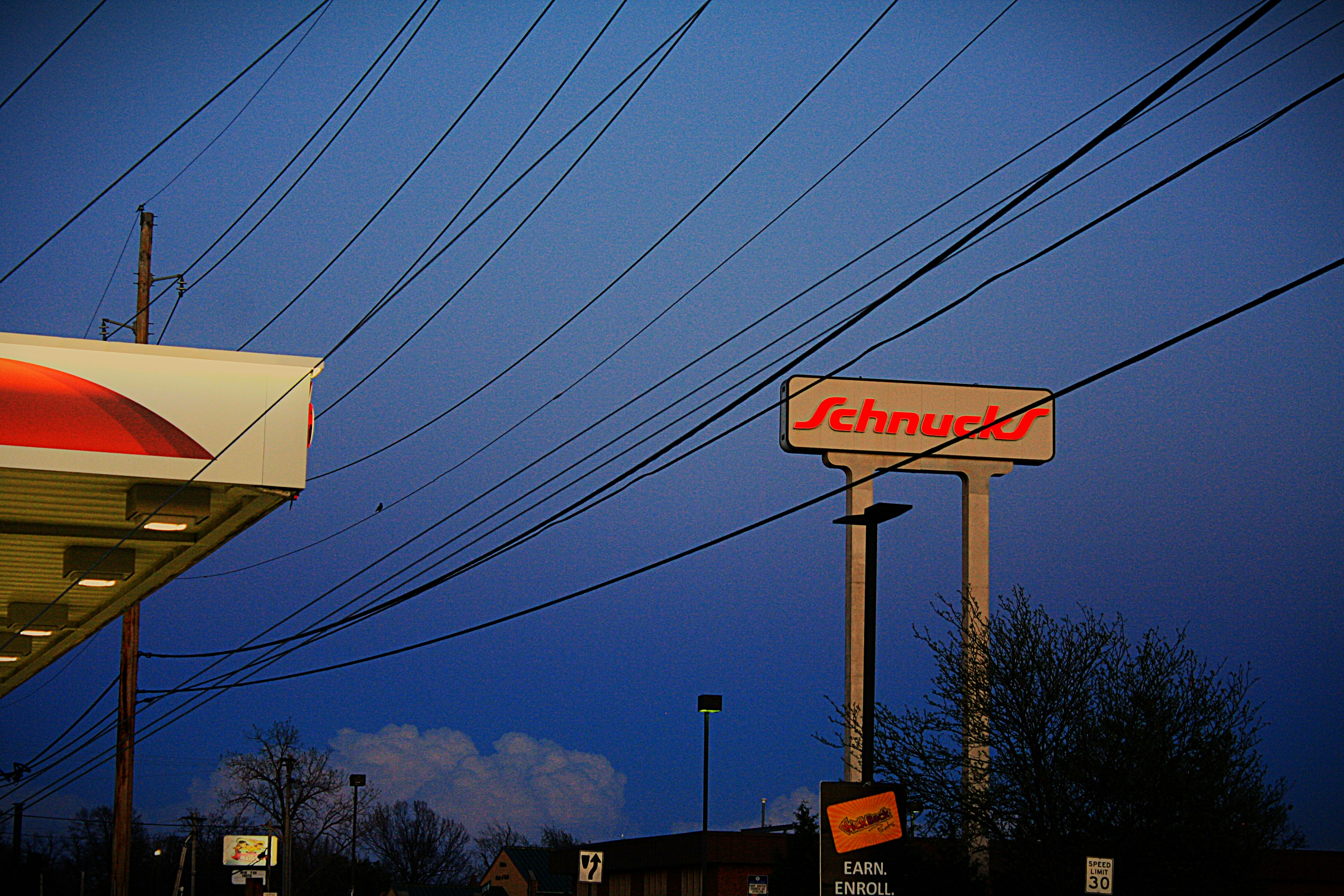 Schnuck's sign and gas station under a dark sky. photo – Free Outdoors ...
