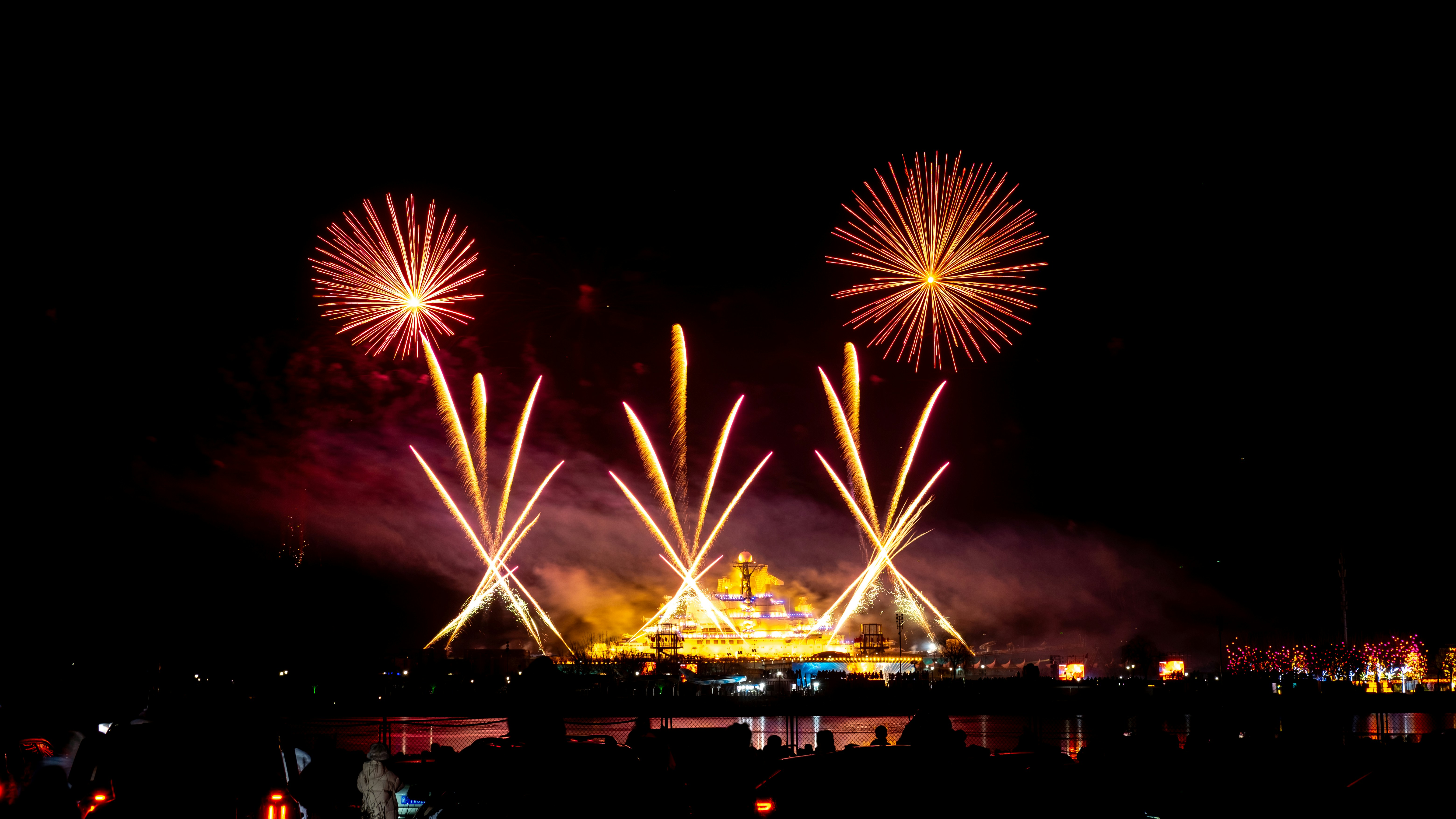 Fireworks light up the night sky over a building. photo – Free Human ...