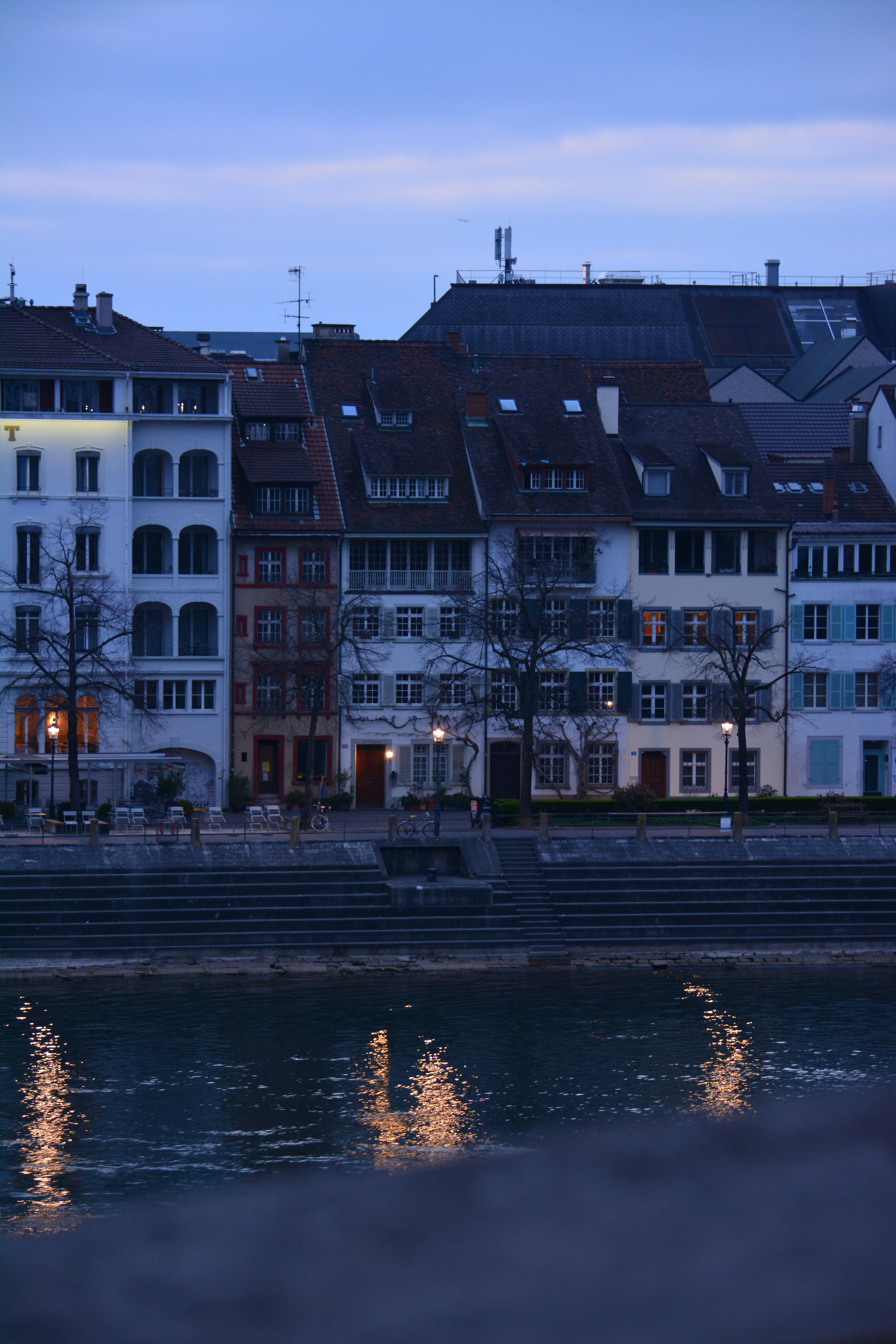 Blue Hour Riverside Row: Facades, Warm Windows, and Water Reflections