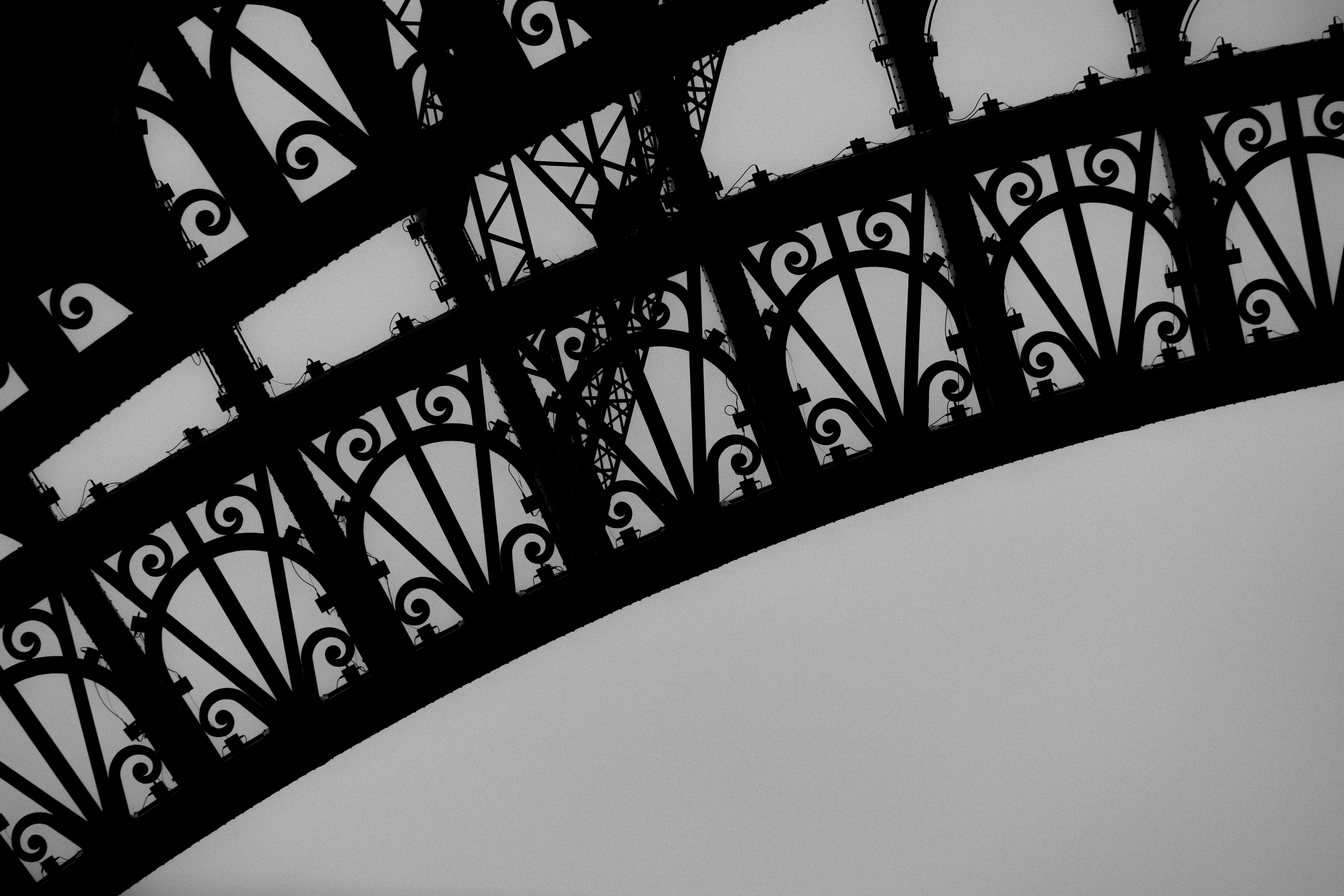 Monochrome Iron Lace: Repeating Motifs on a Curved Arch