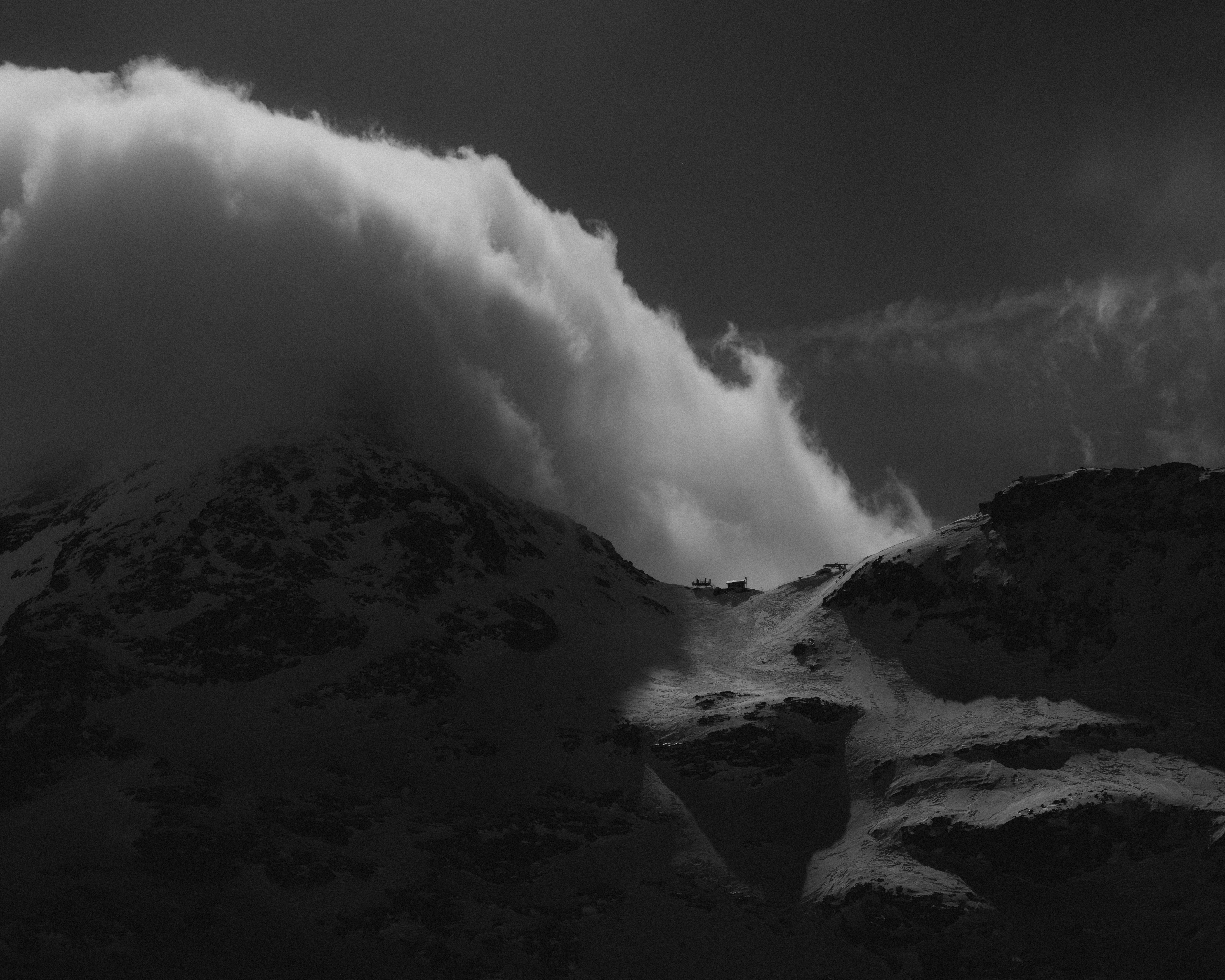 Clouds cascade over snow-covered mountain peaks. photo – Free Portrait ...