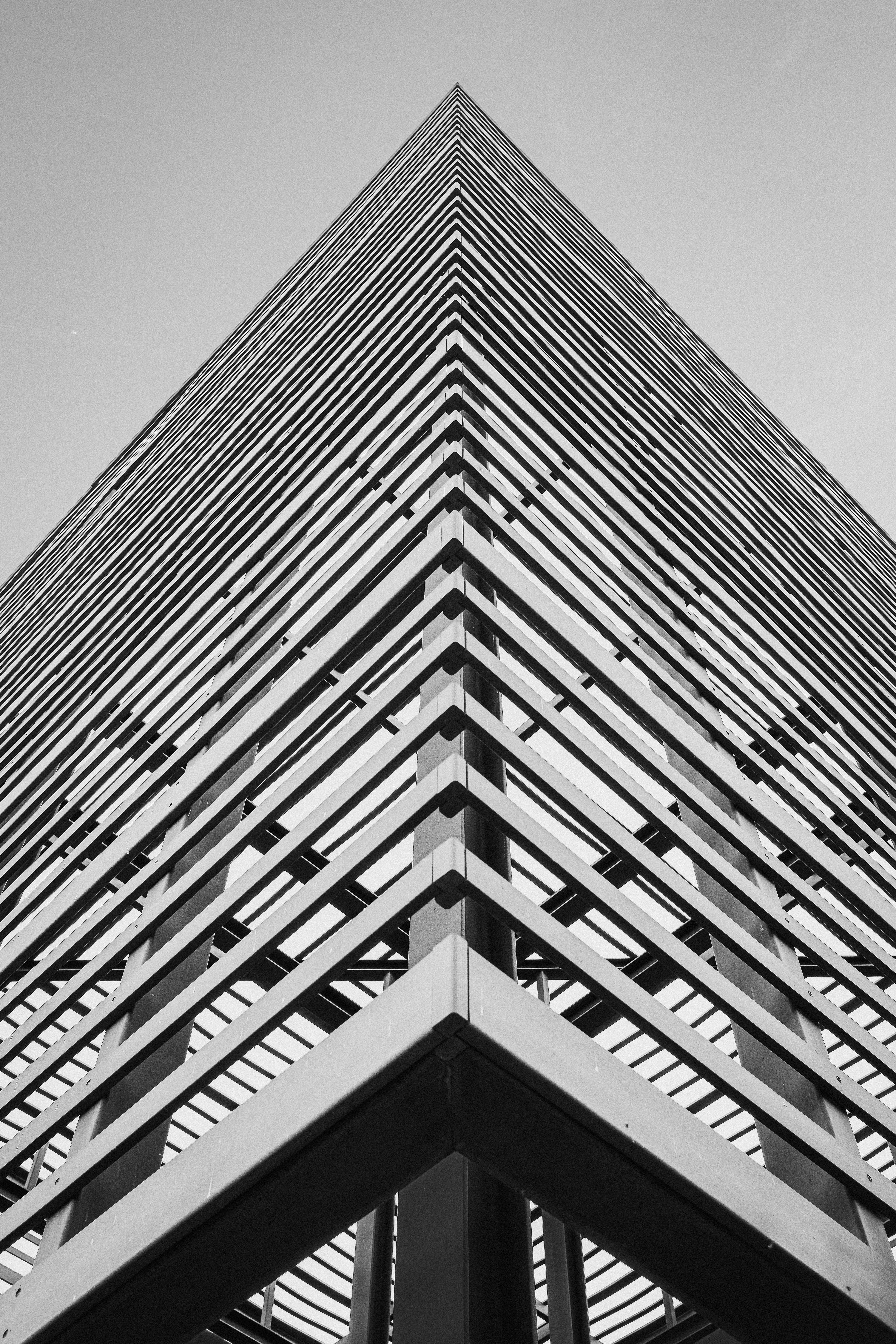 Monochrome architectural structure with converging lines creating a striking geometric pattern.