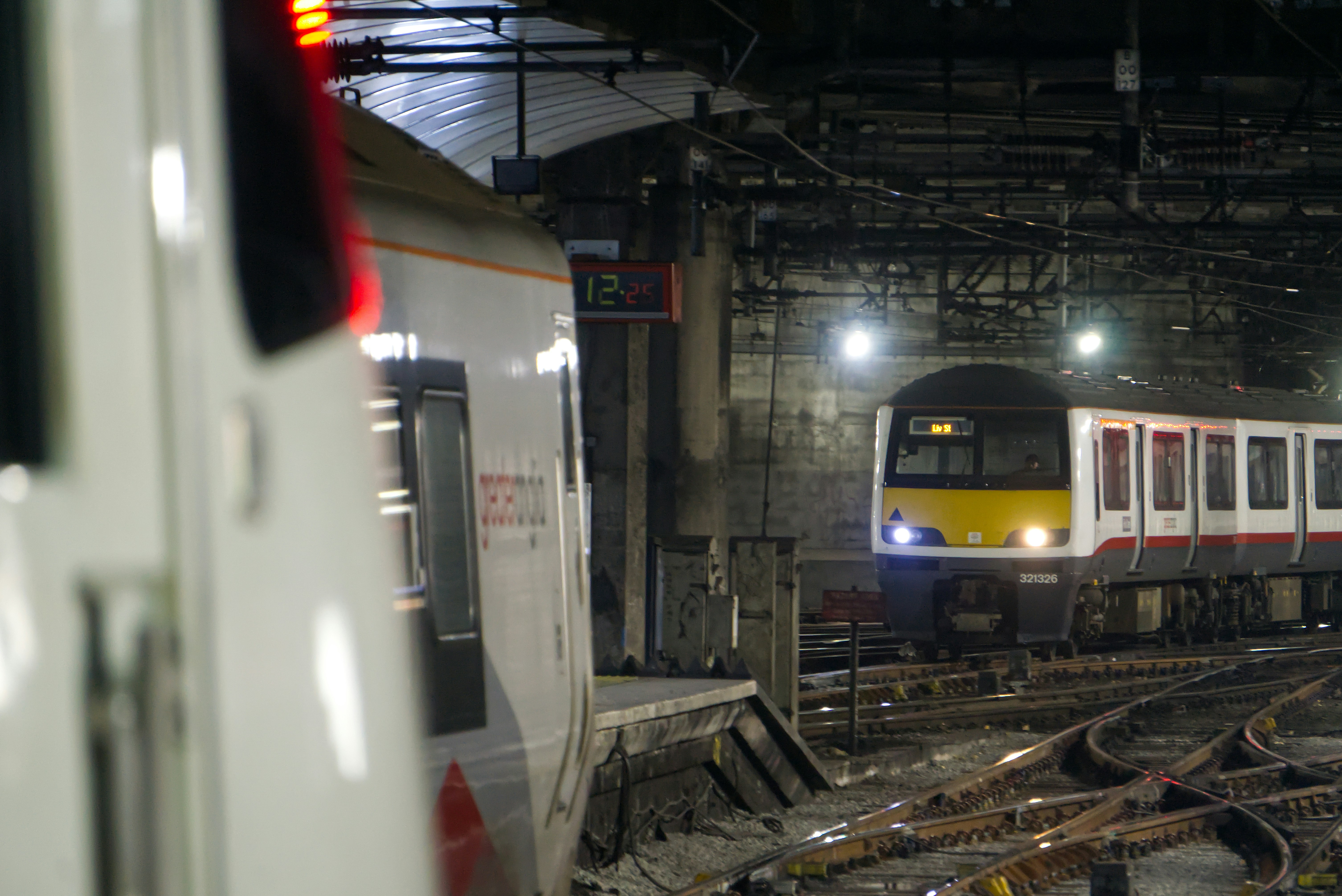 Headlight Frontier: A Train Pierces the Night Through the Iron Maze