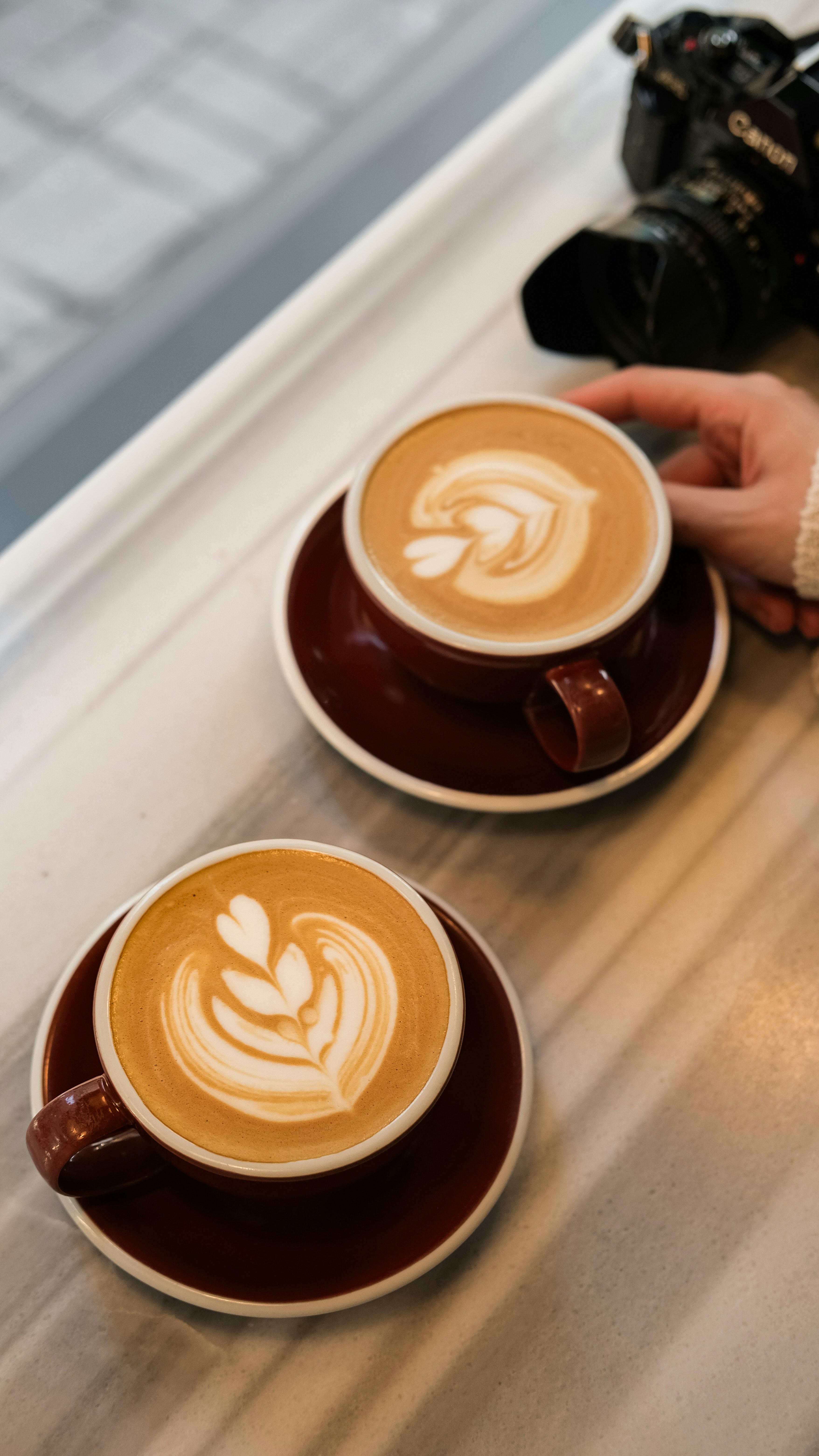 Rosette Duet on Marble: A Pair of Latte Art Cups