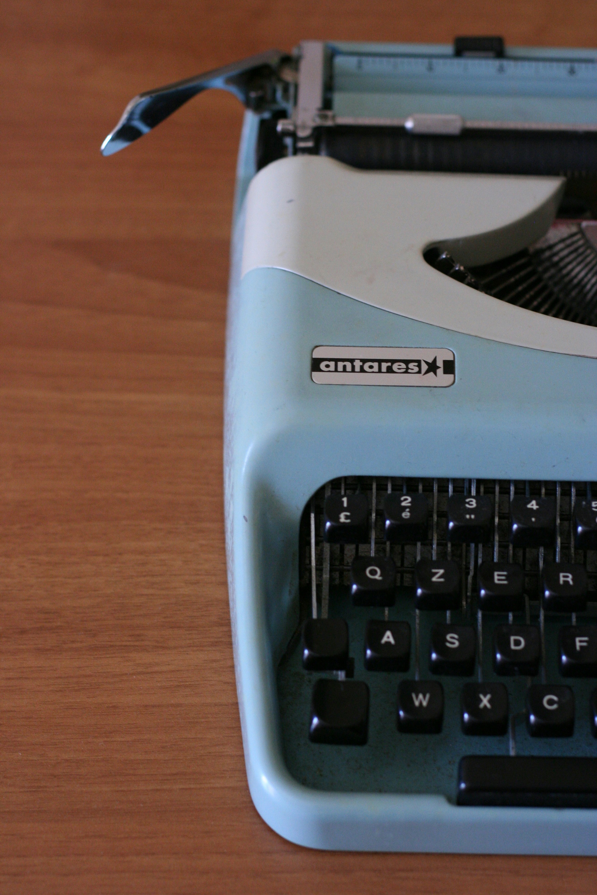 Pastel Blue Antares Typewriter: Quiet Vintage on a Wooden Desk
