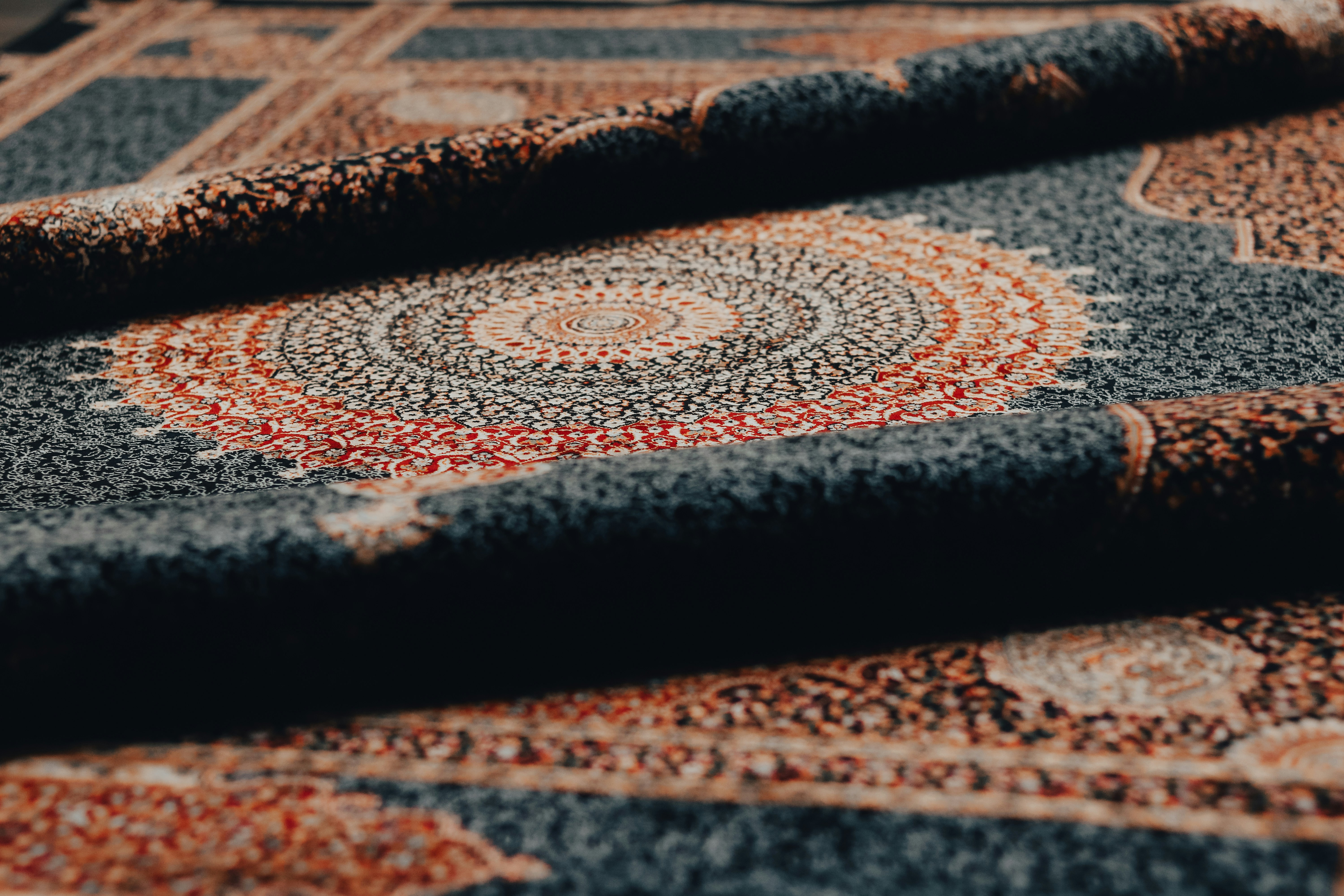 Rolled-up rug shows intricate pattern and detail. photo – Free ...