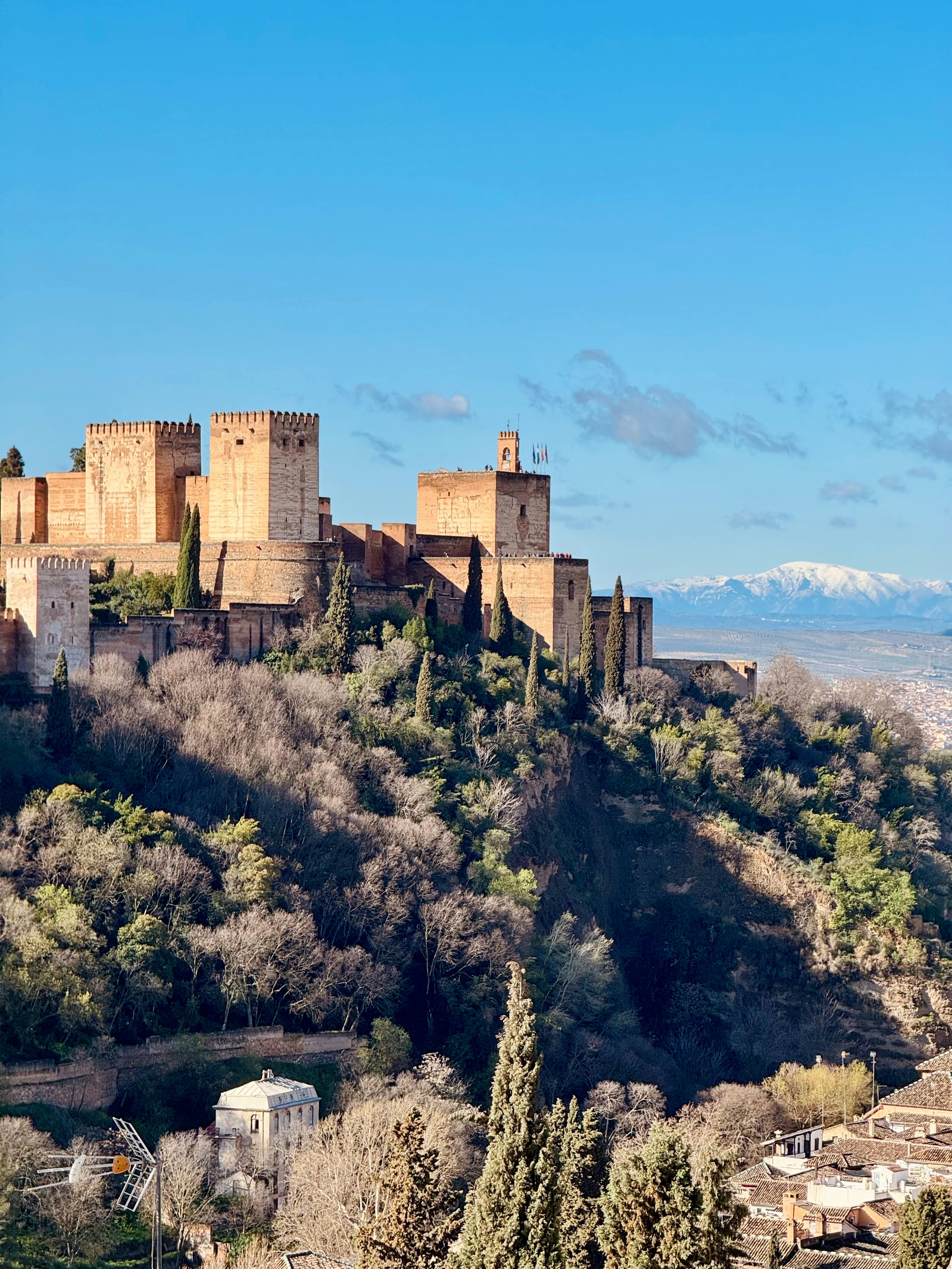 The alhambra palace rises above a scenic landscape.