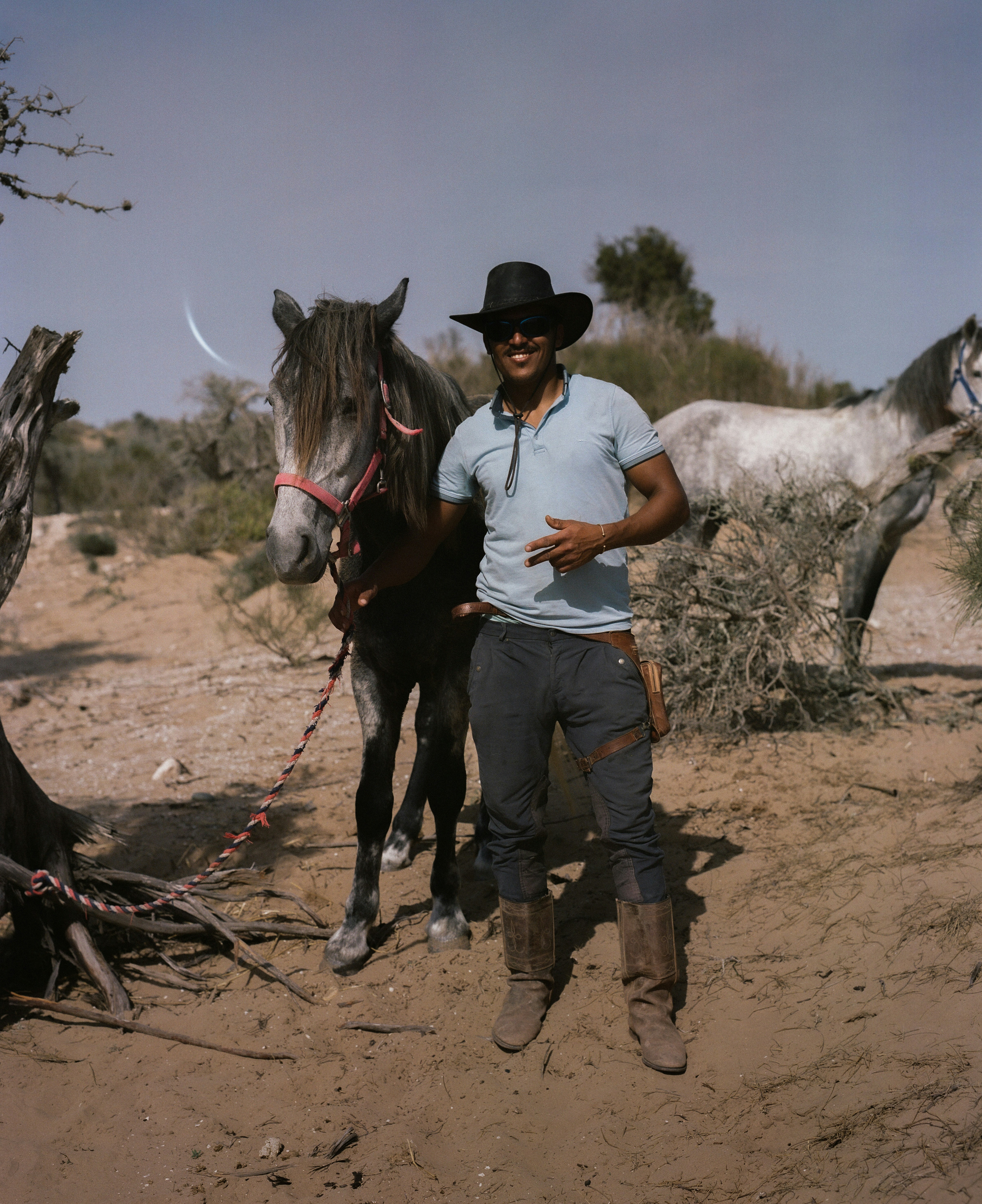 A cowboy poses with his horse in the desert. photo – Free Portrait ...
