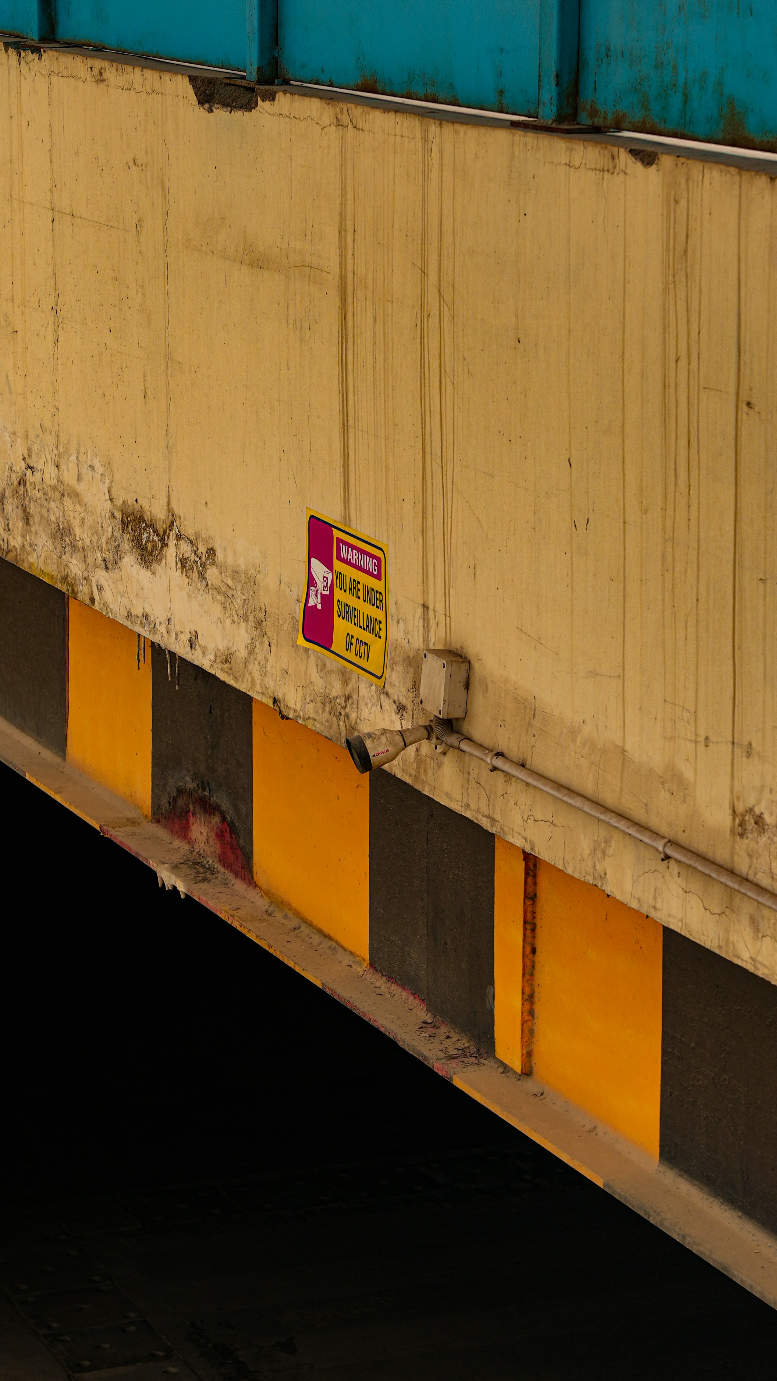 A concrete structure with warning signs and painted stripes. photo ...