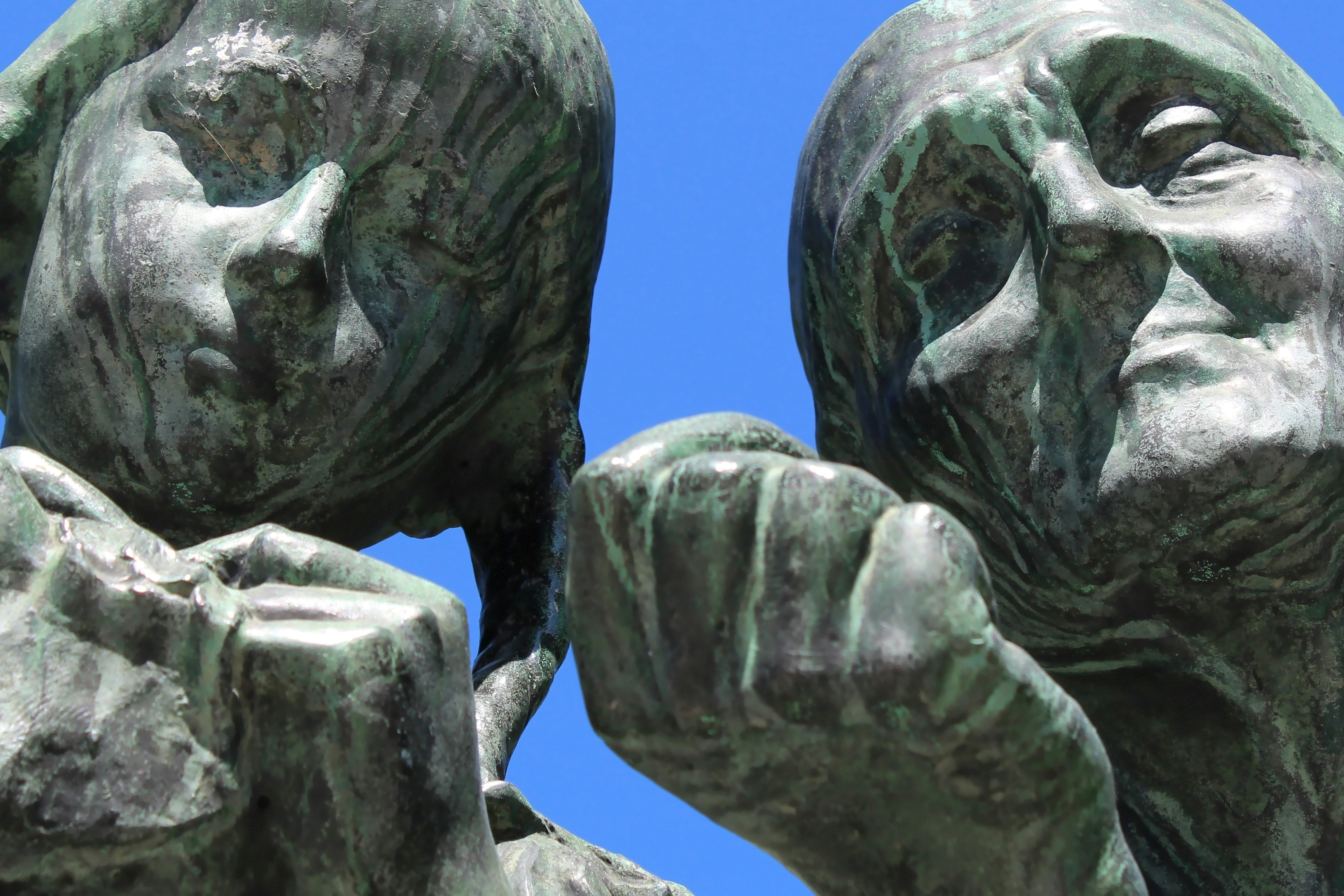 Two bronze statues look pensively at each other. photo – Free Woman ...
