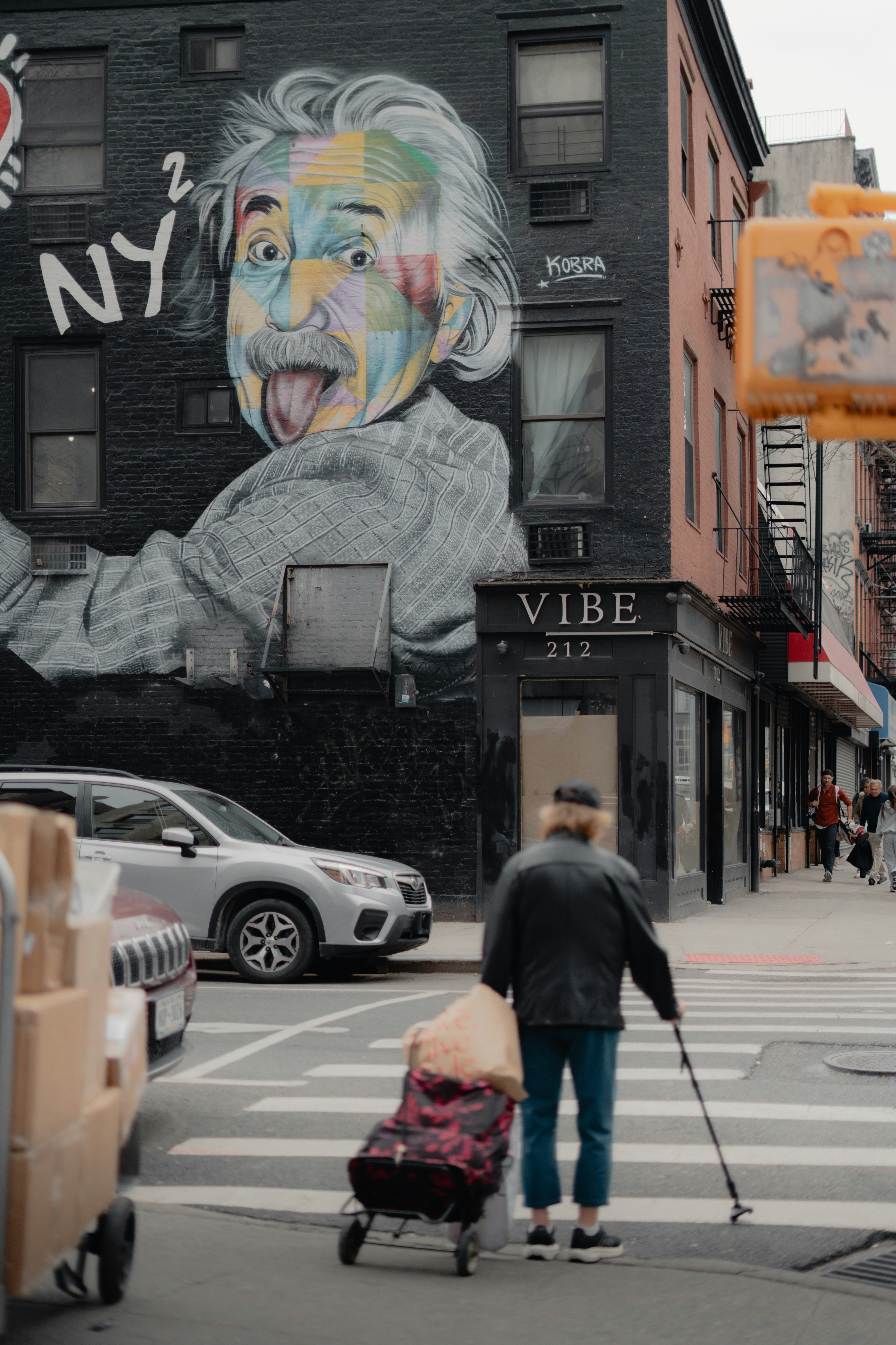 Street scene featuring an einstein mural and pedestrian. photo – Free ...