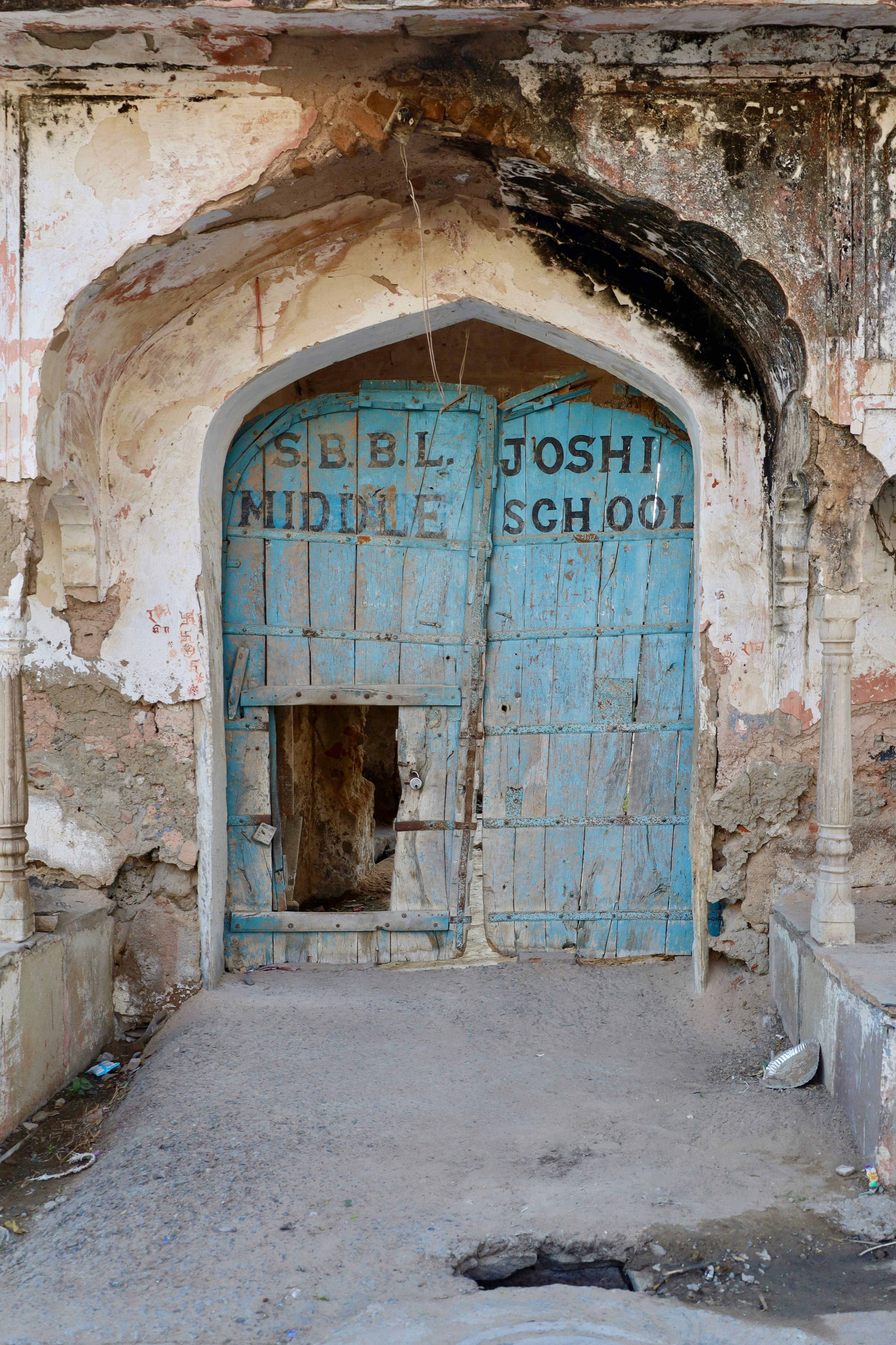 Old, crumbling school entrance with peeling blue door. photo – Free ...