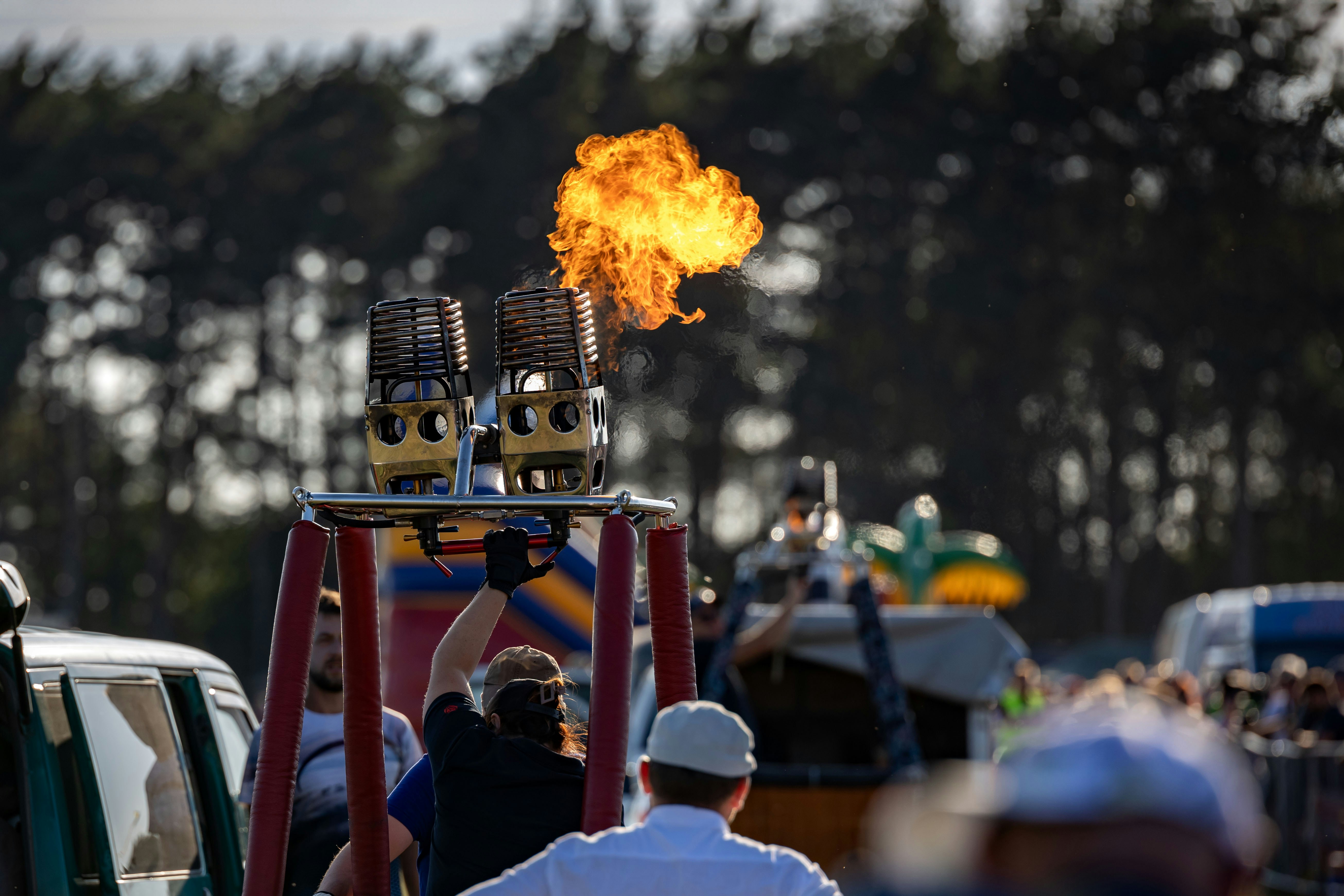 Twin Burners Ignite Above a Balloon Launch as Crowd Gathers