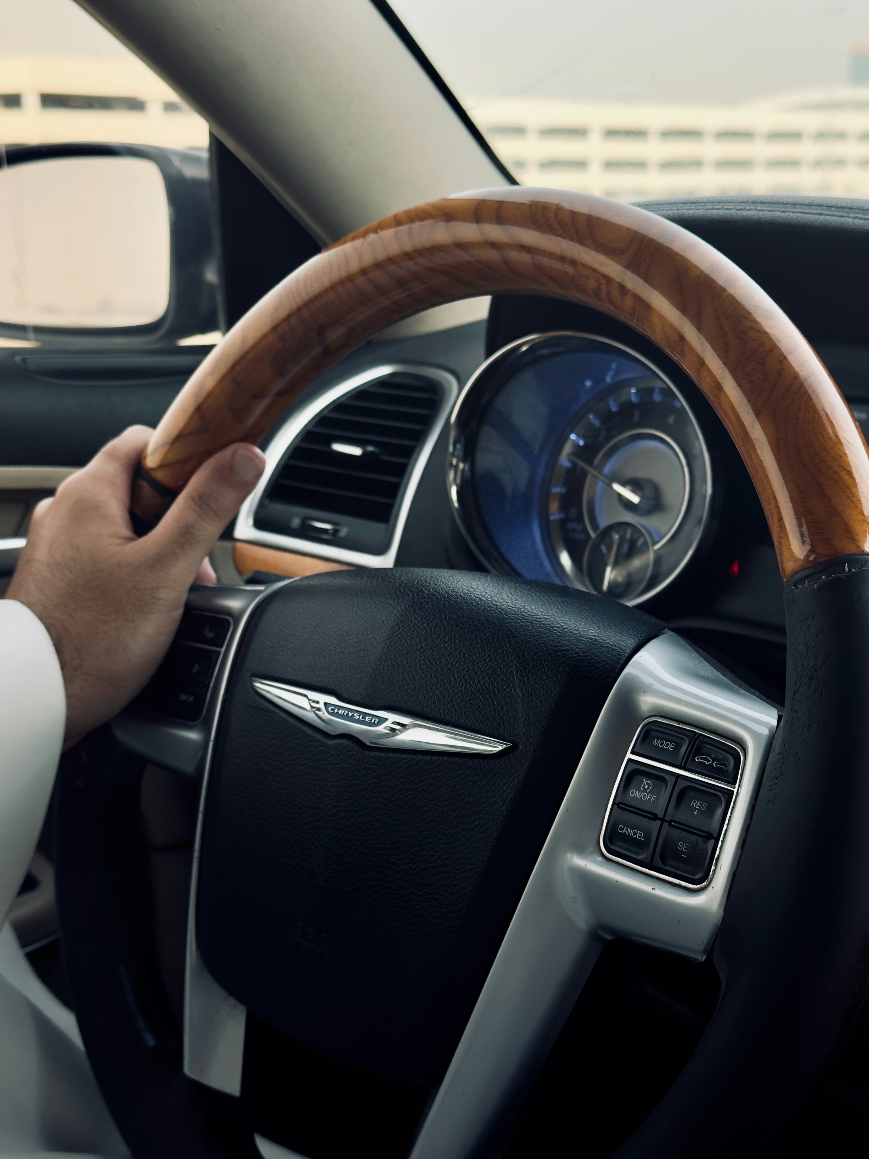 A hand grips the steering wheel of a car. photo – Free Car Image on ...