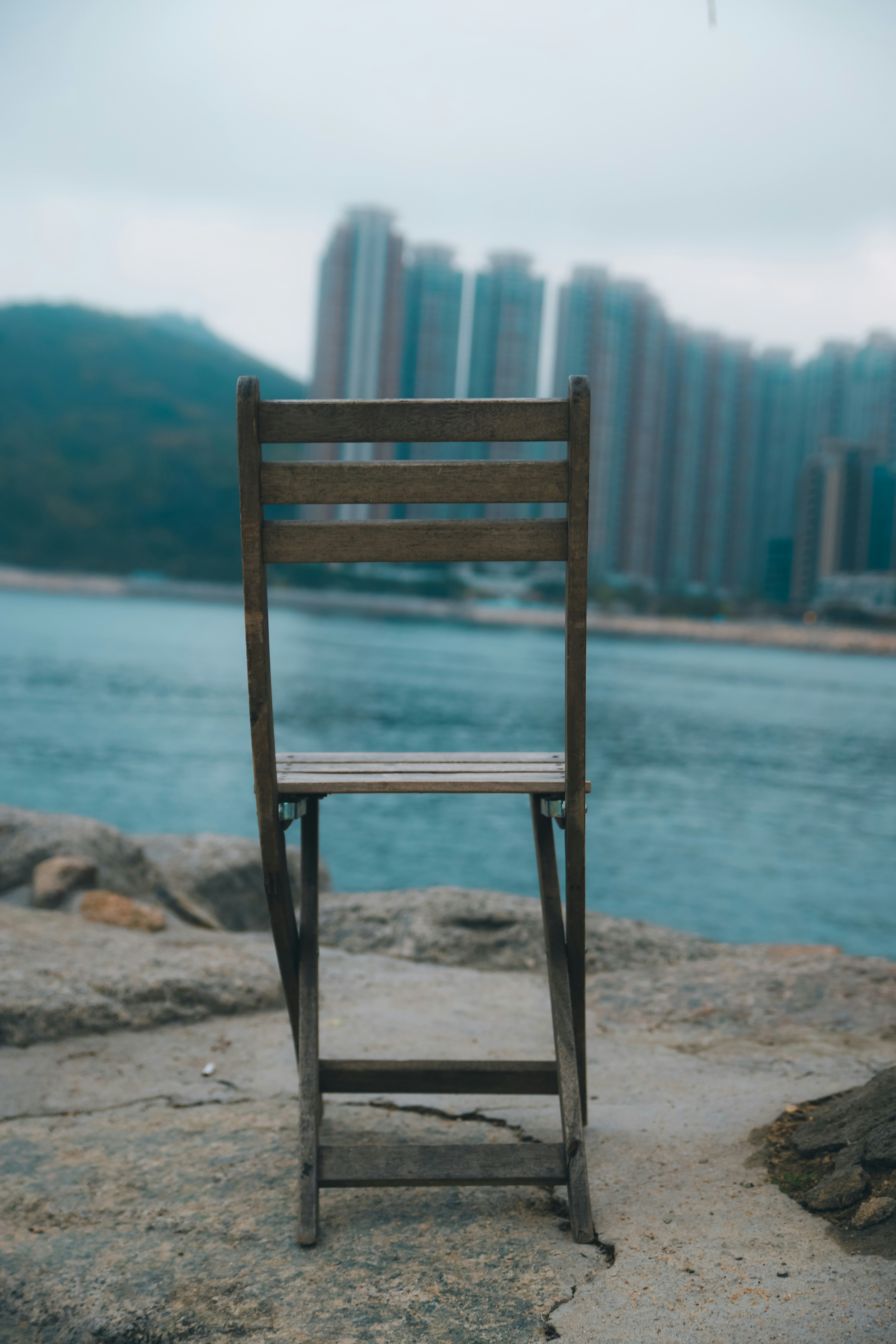 A wooden chair sits before a scenic waterfront view. photo – Free Beach ...