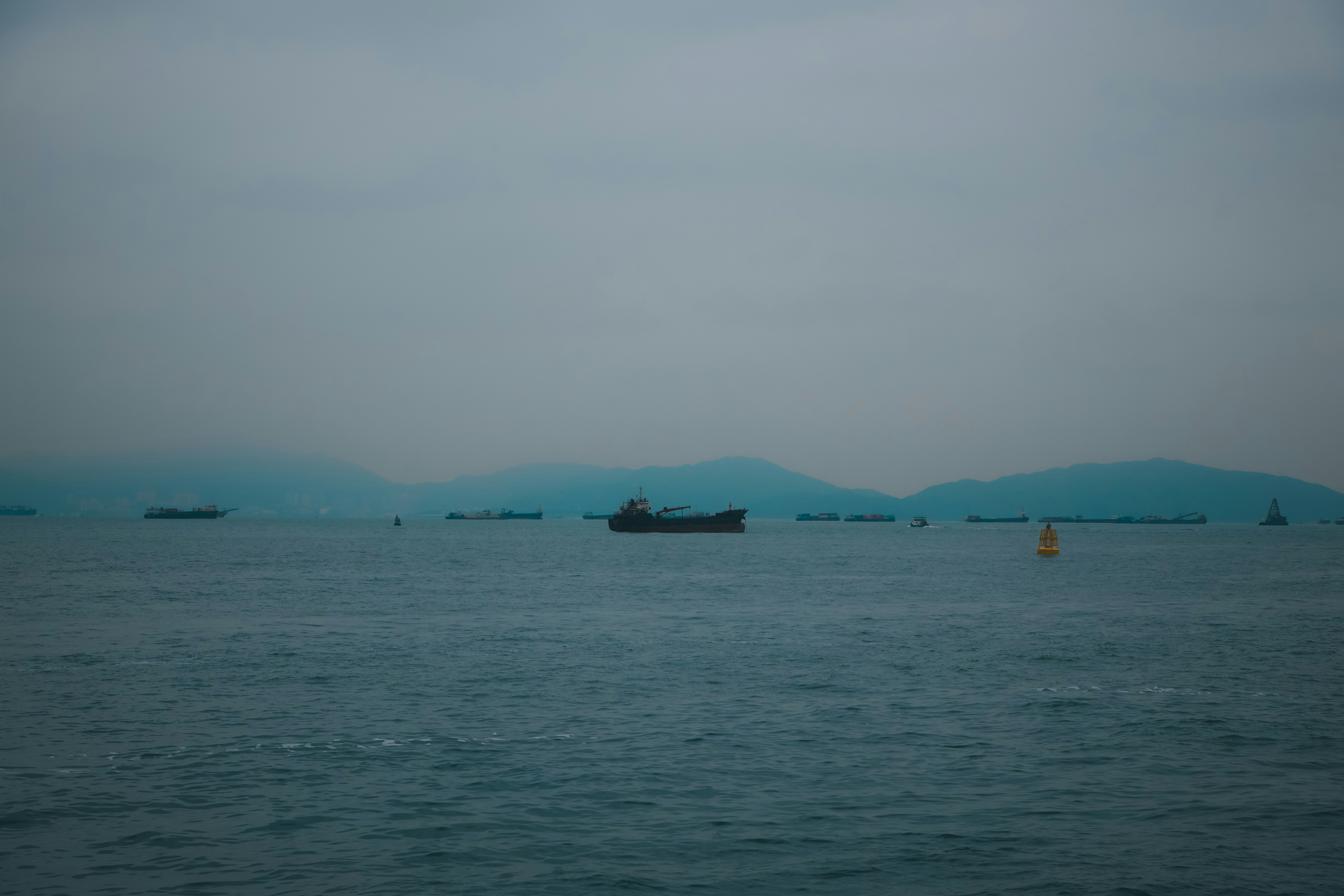 Drift in a Mist-Blue Sea: A Fleet at the Horizon