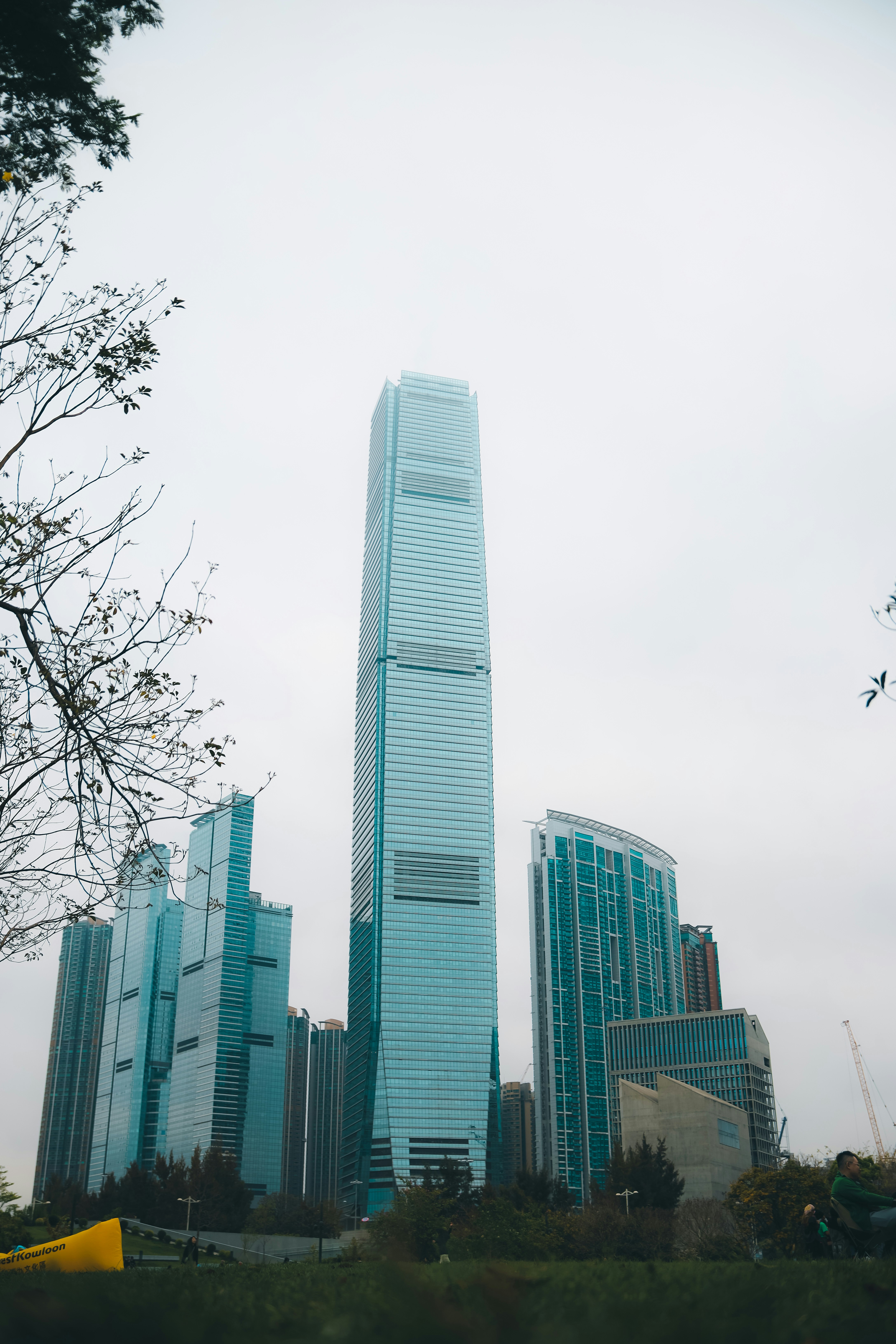 A tall skyscraper reaches high above other buildings. photo – Free City ...