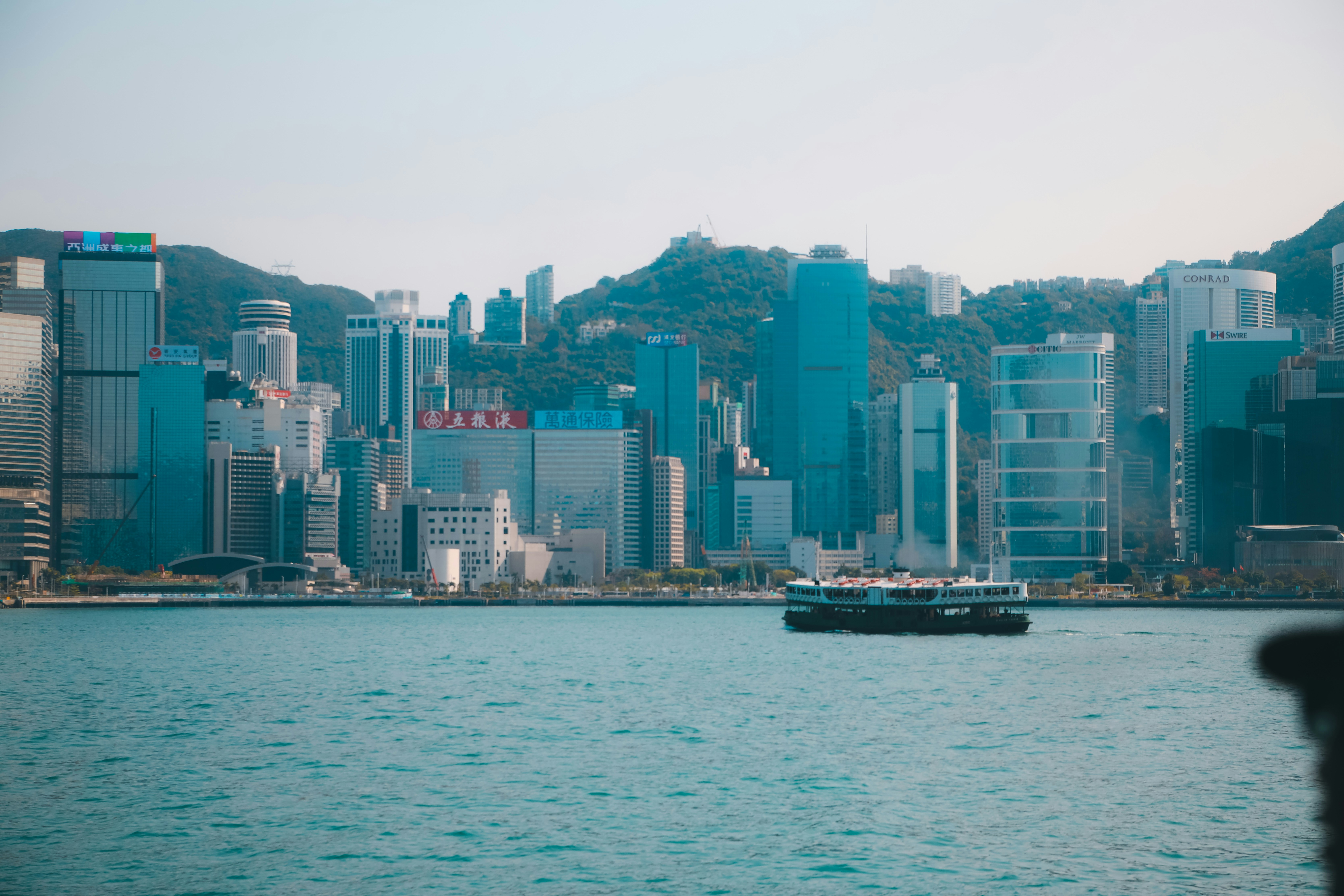 Cityscape with tall buildings by the water. photo – Free Sea Image on ...