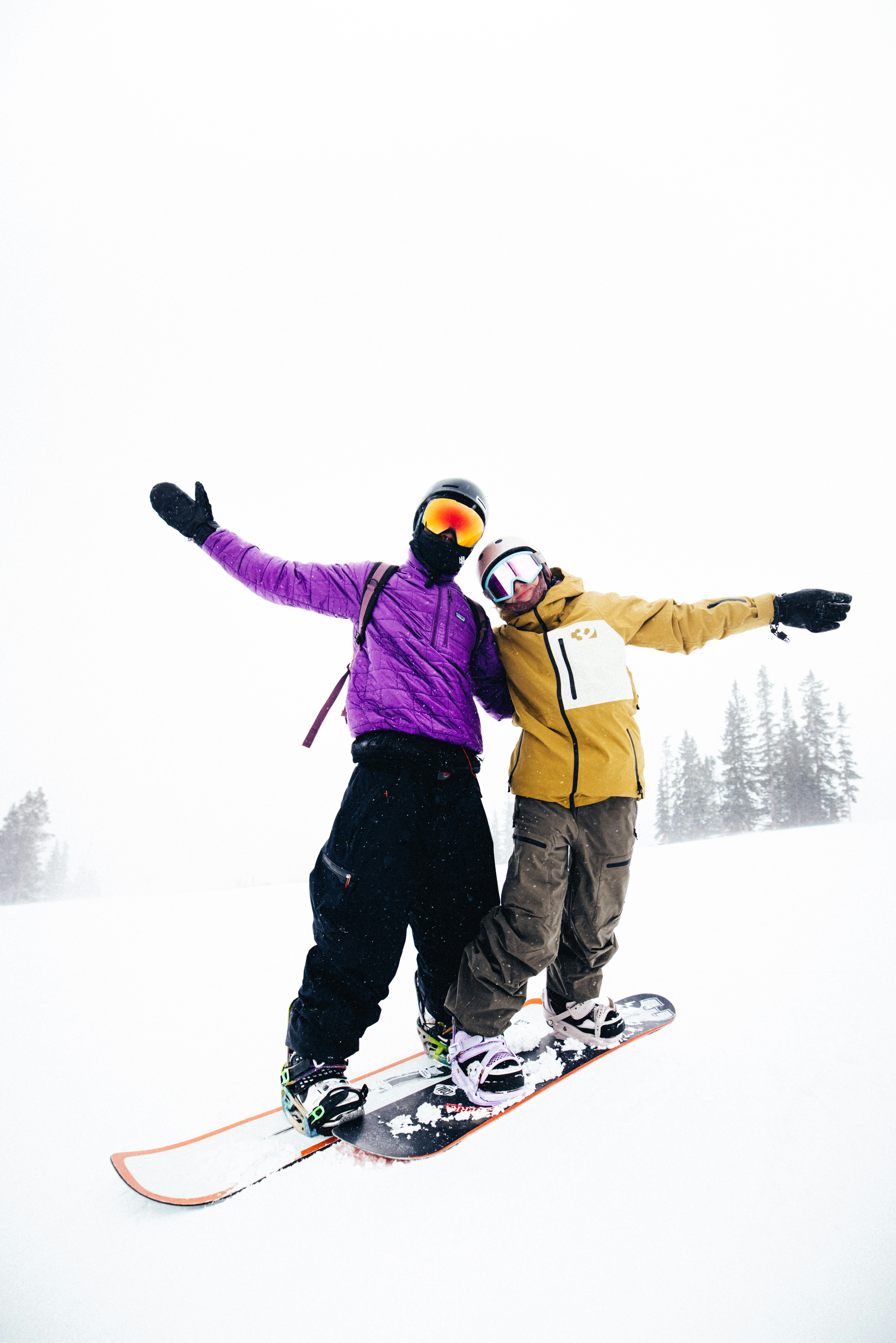 Two snowboarders celebrate on a snowy mountain. photo – Free Portrait ...