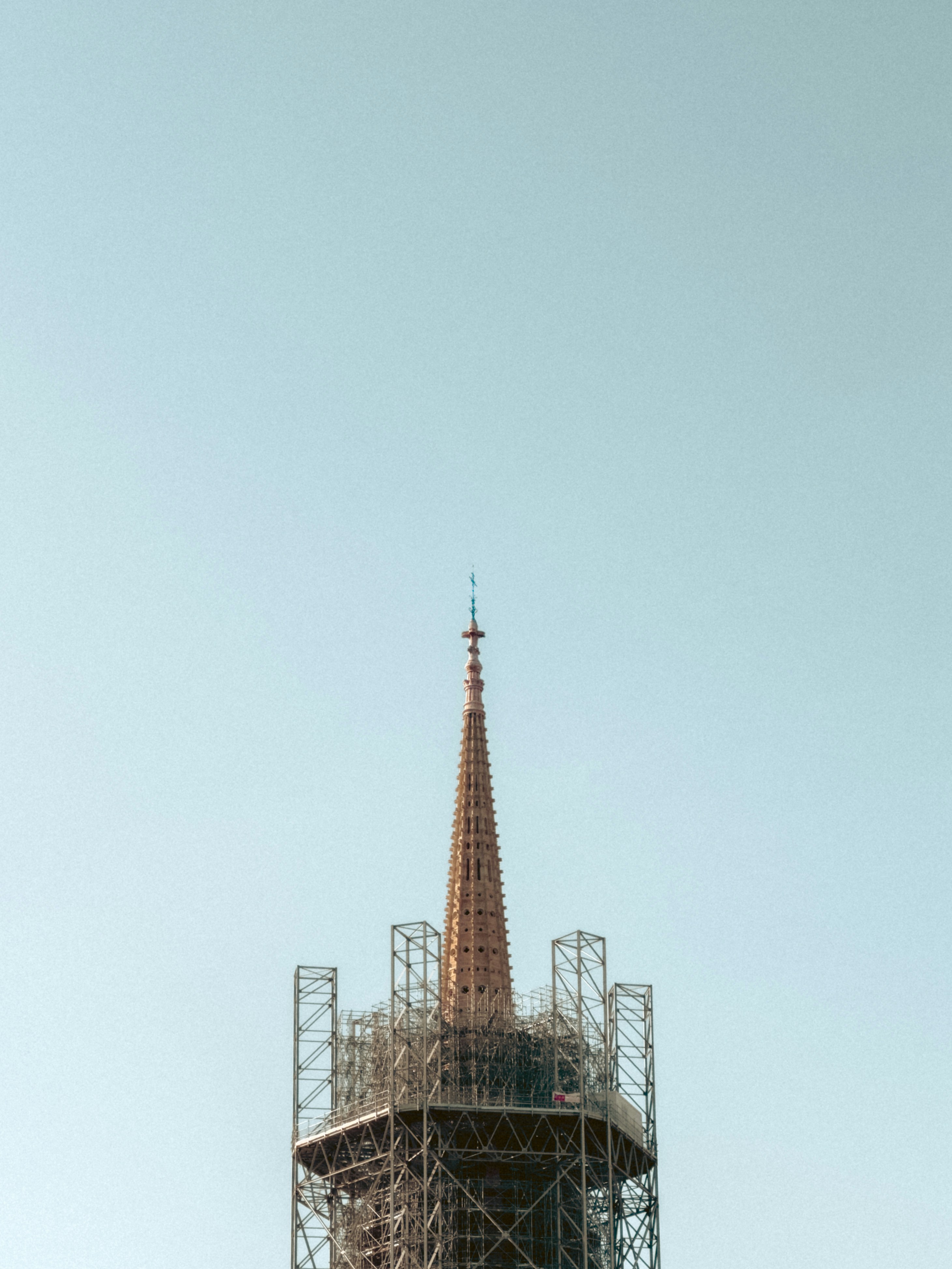 A tall church spire is under construction. photo – Free City Image on ...