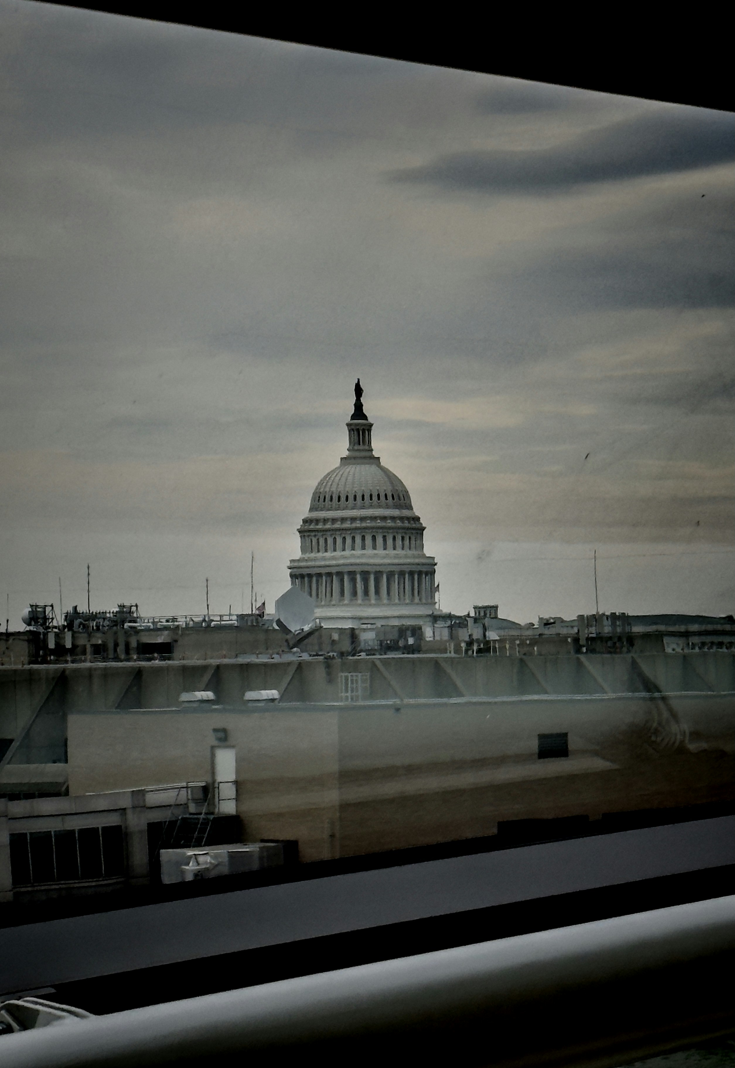The u.s. capitol building viewed through a window.