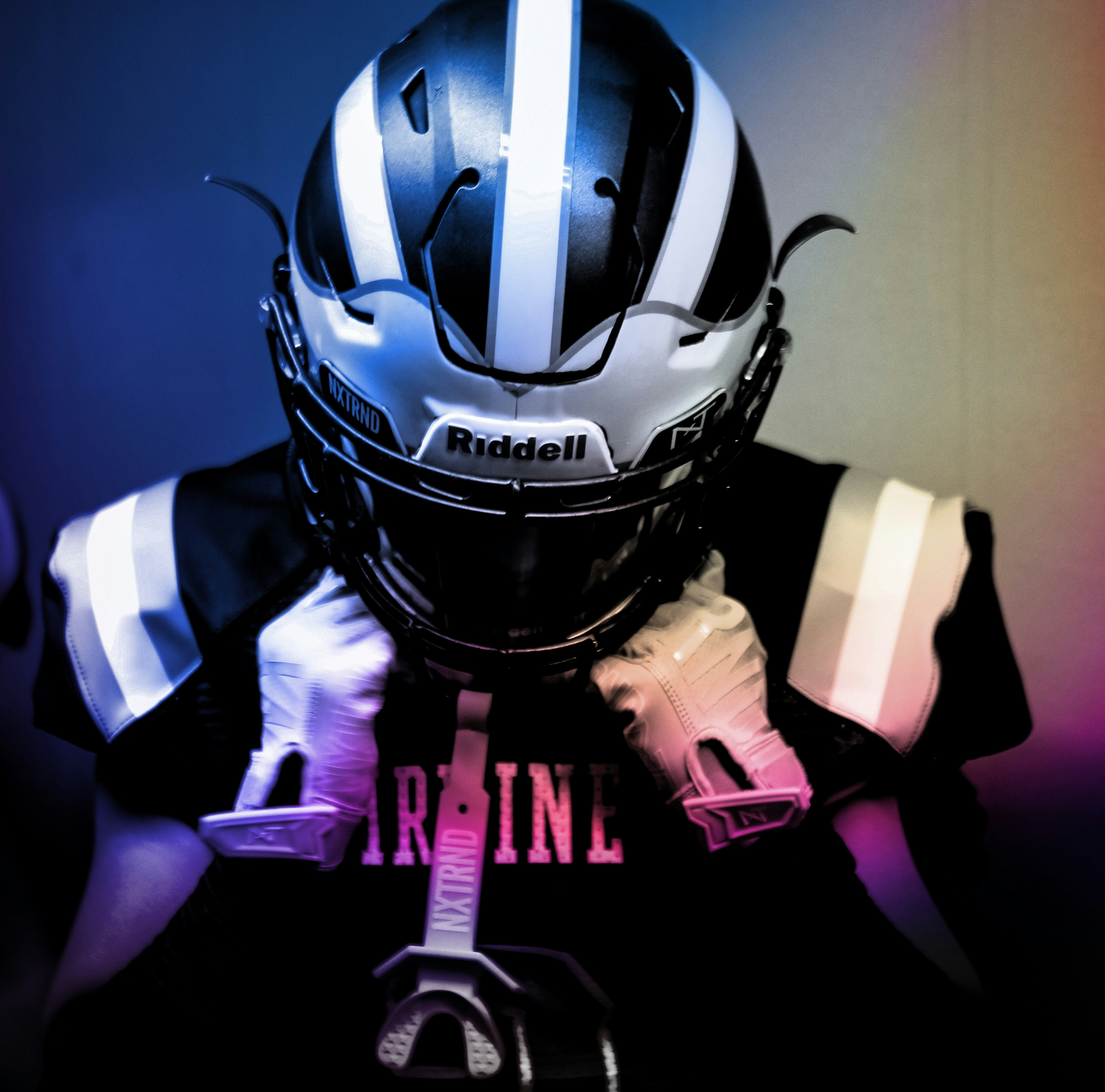 Neon Prism Portrait: A Riddell Helmet Under Multicolor Light