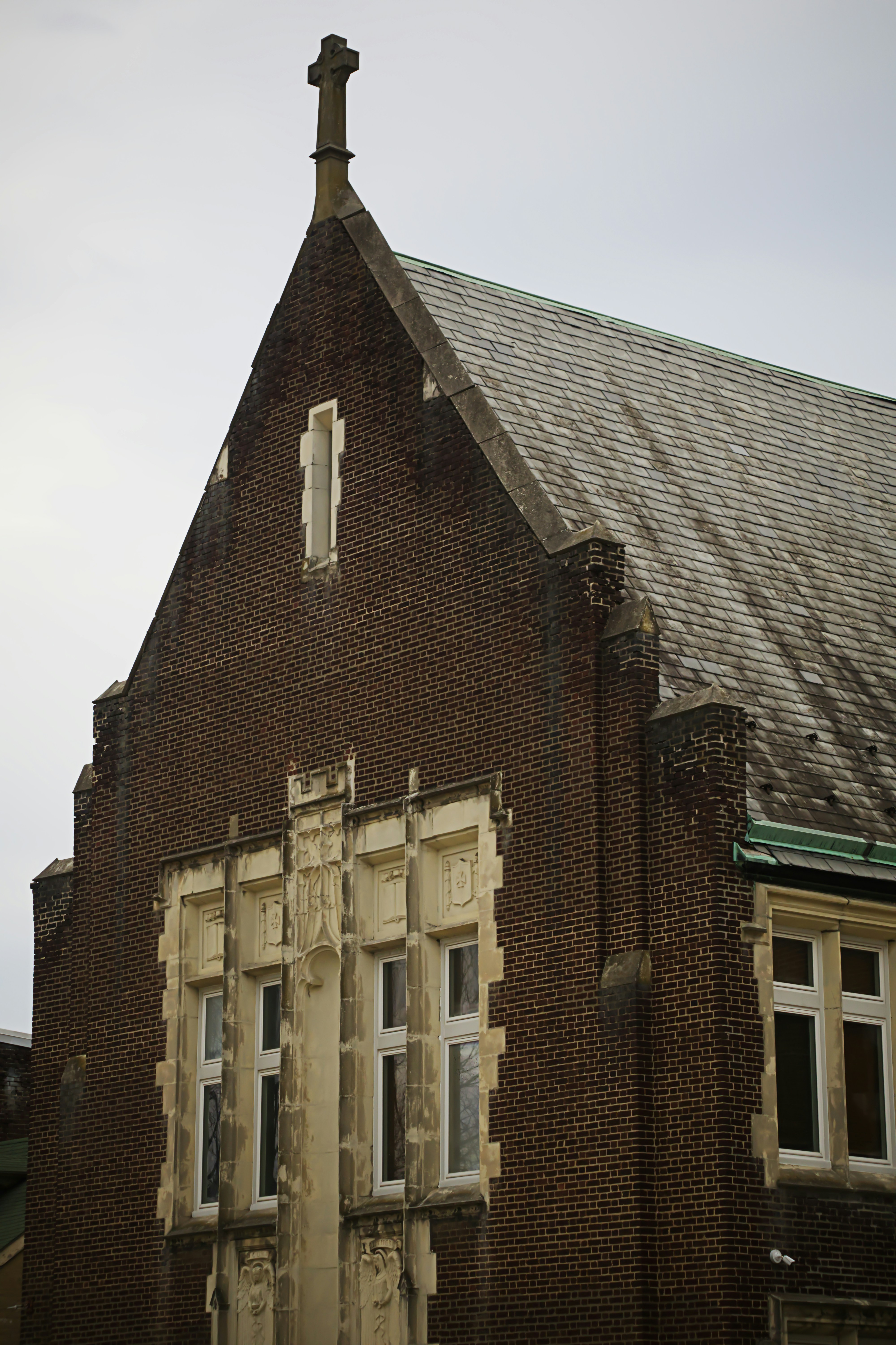 A brick church building topped with a cross. photo – Free Building ...