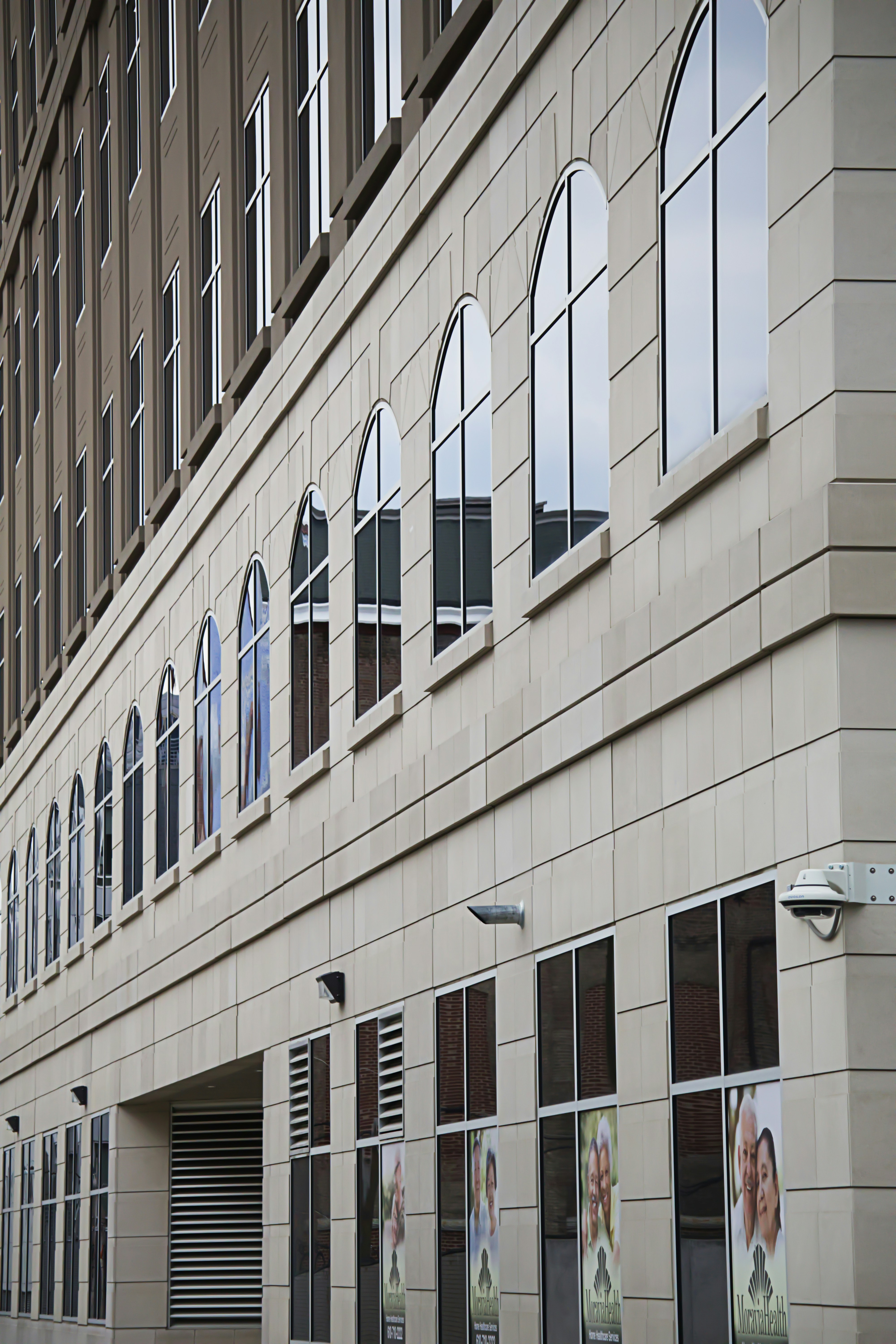 A modern building features arched and rectangular windows. photo – Free ...